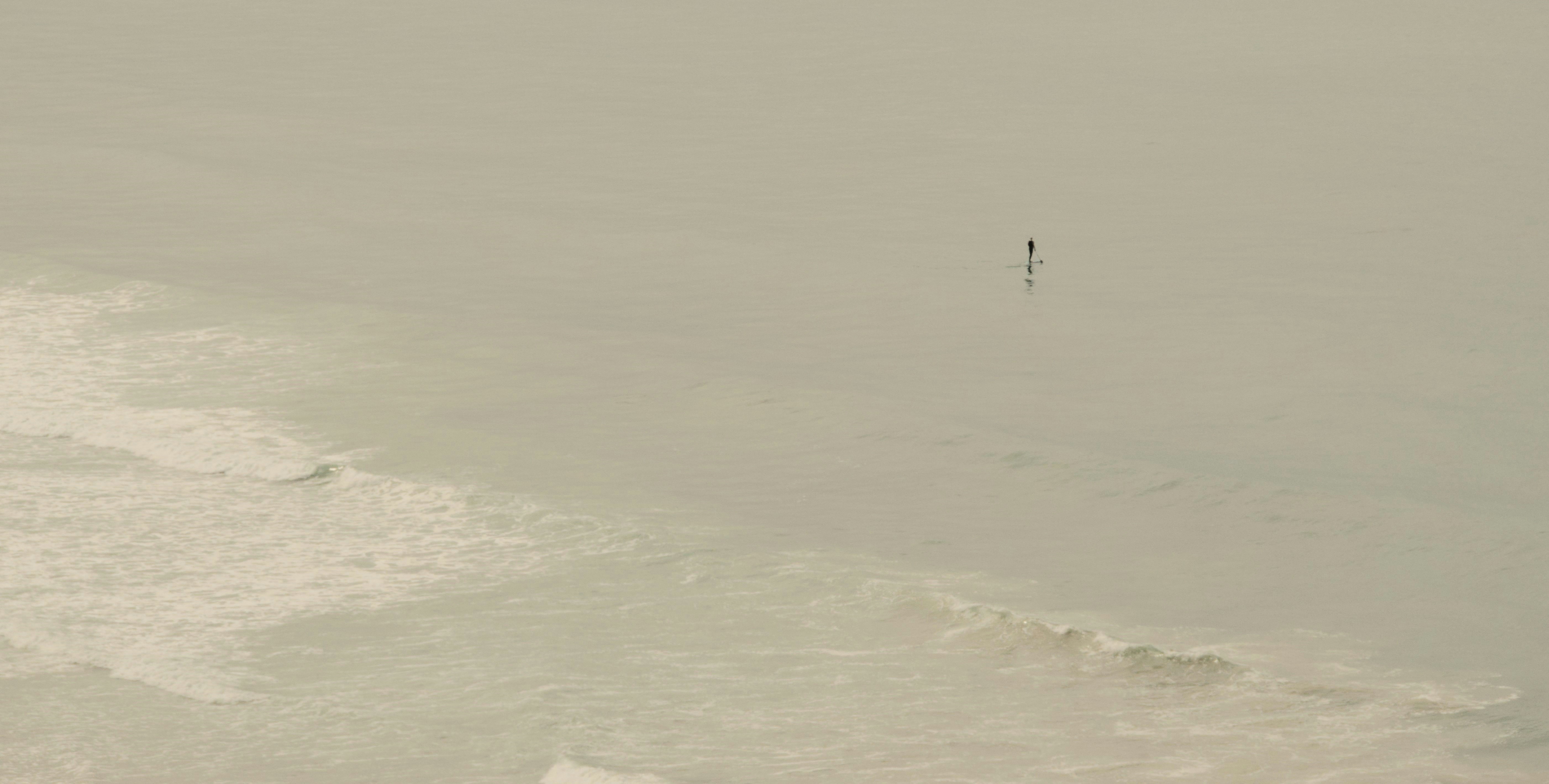 Distant Silhouettes on a Pale Coastal Sea