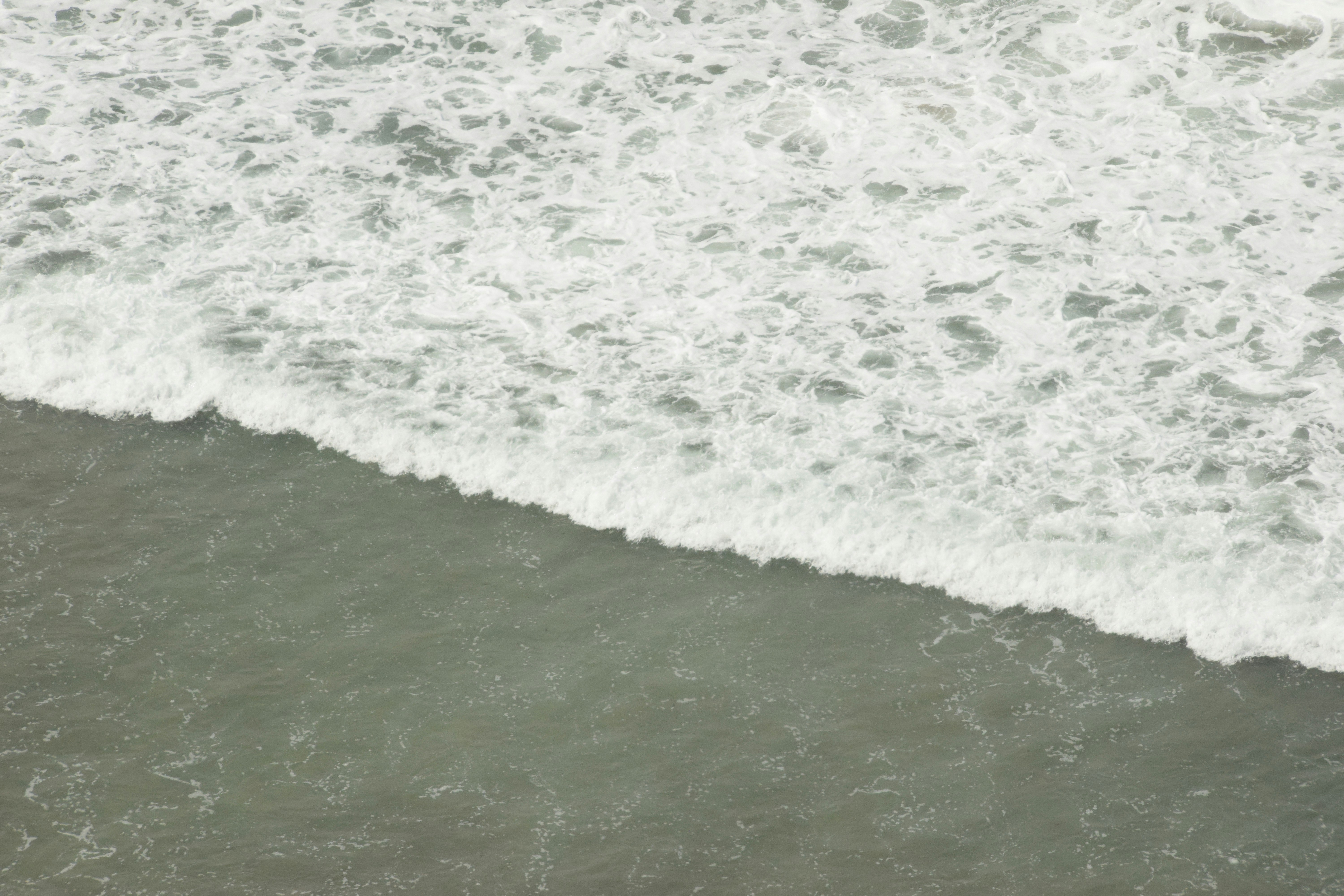 Ocean waves crashing on a sandy shore