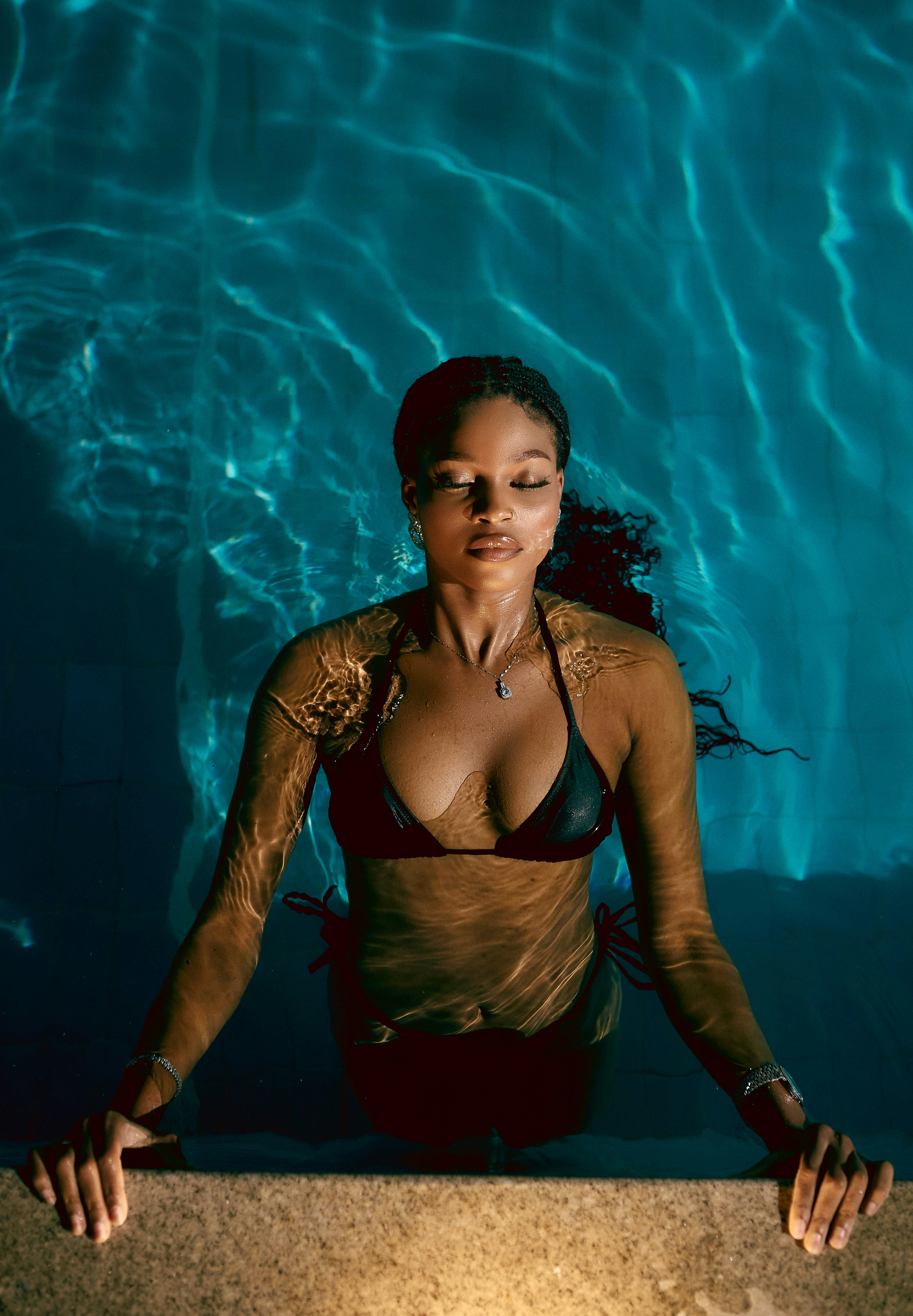 Photos by the pool. | Woman relaxing in a swimming pool at night