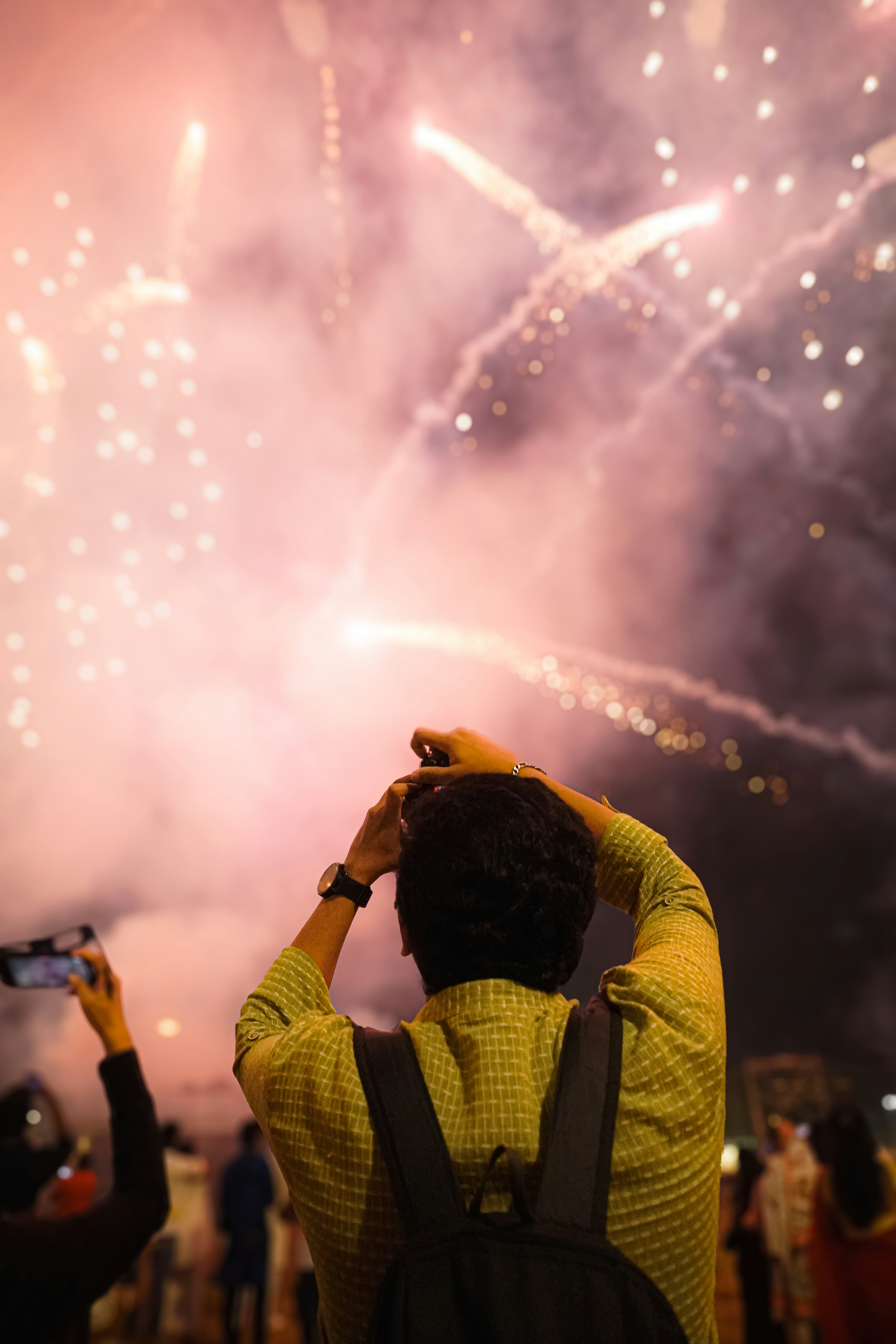 Gaze at the Spark: A Silhouette Amid Firework Bloom