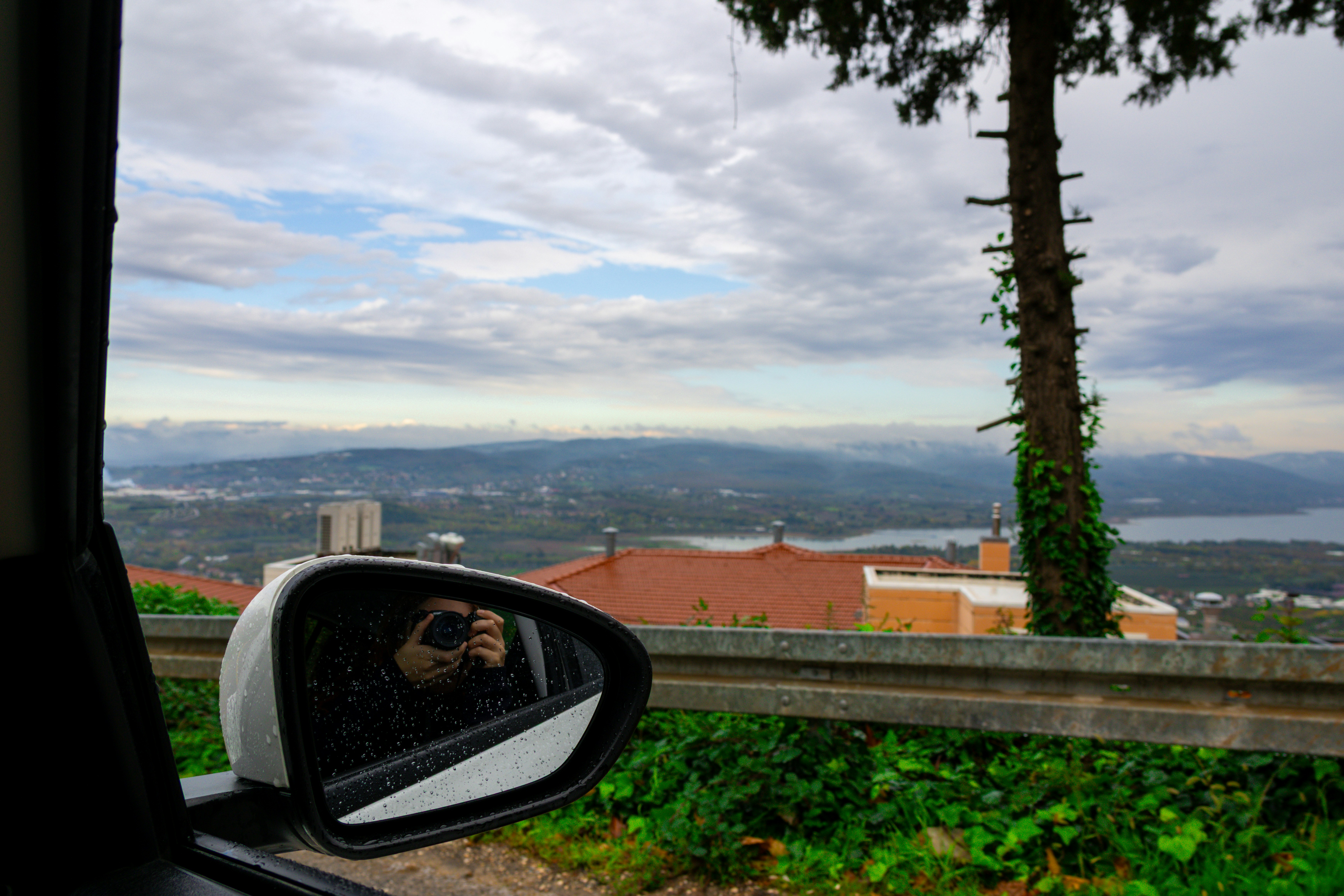 Reflection Through Rain-Speckled Glass: Horizon in a Car Window