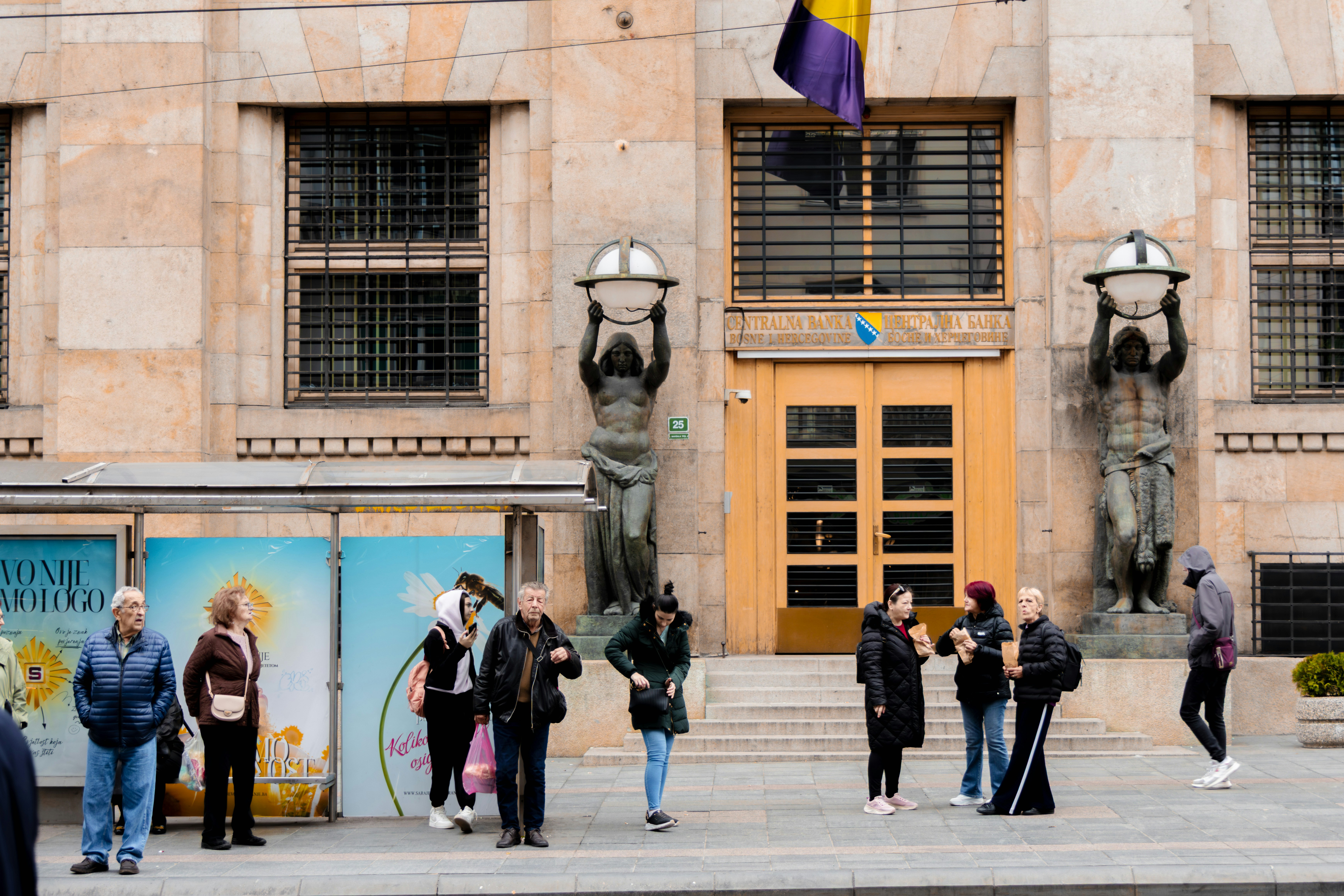 People standing outside a building with statues photo – Free Building ...