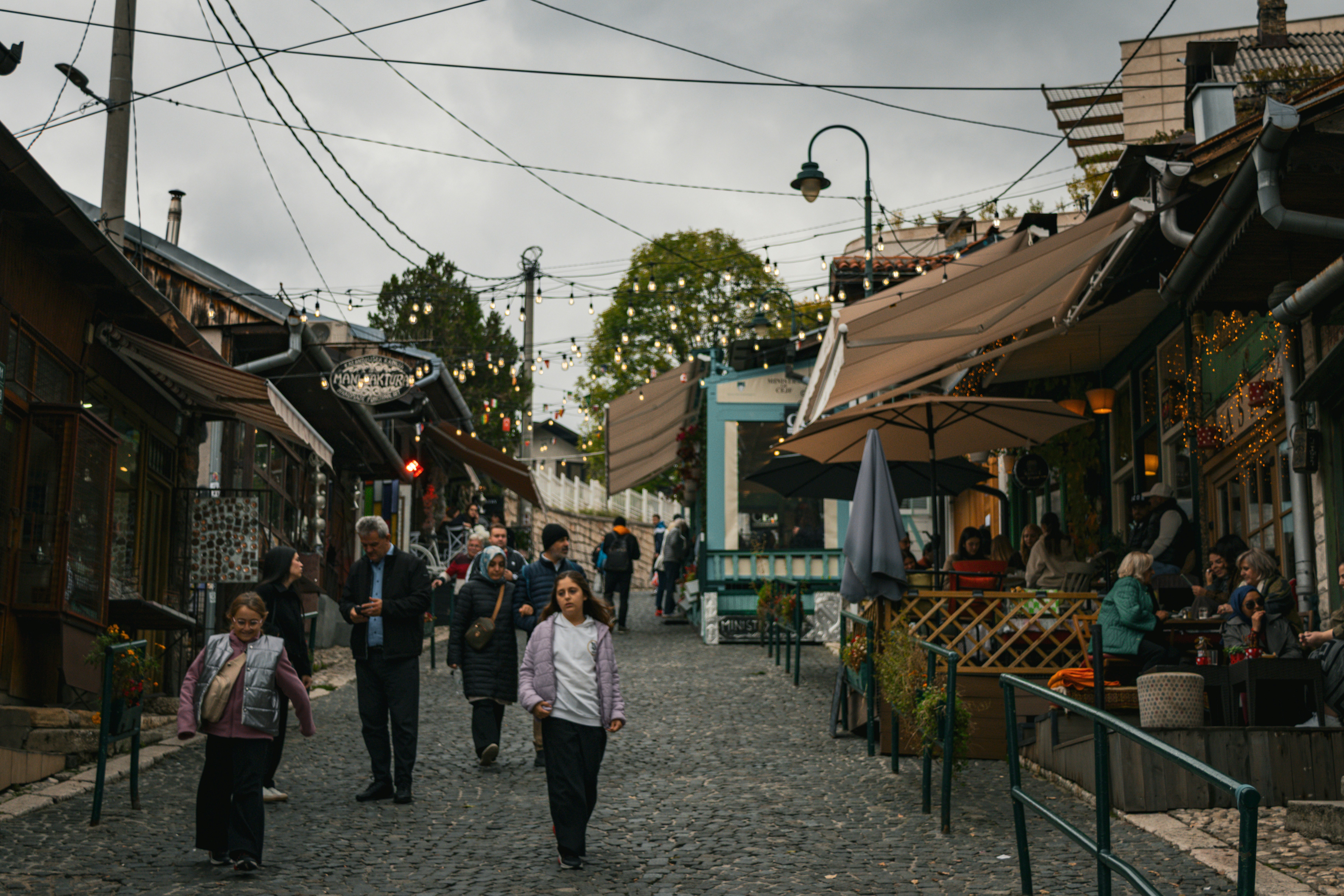 Cobbled Market Lane: Pedestrians Move Through a Quiet Street Café Scene