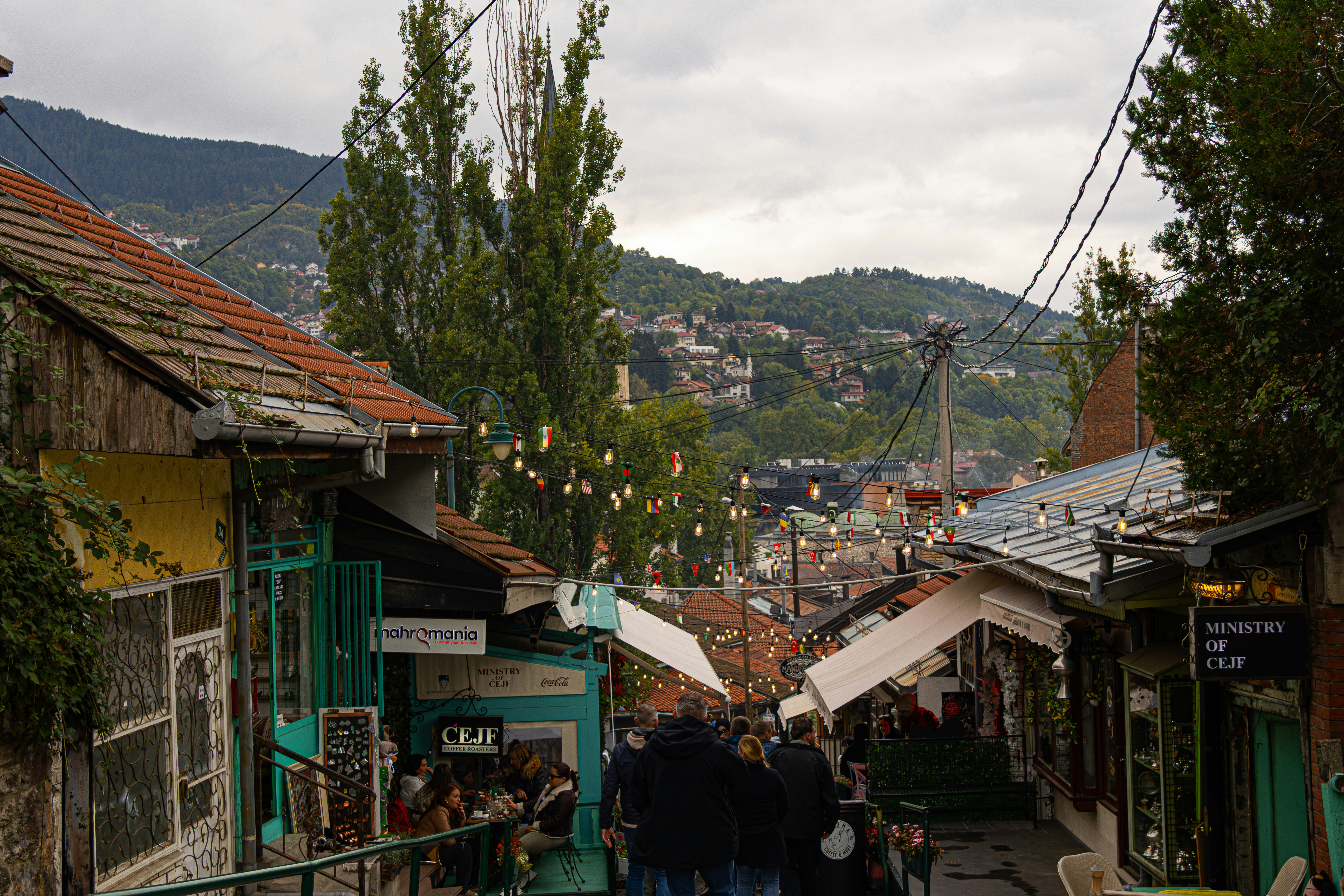 Cobblestone street lined with shops and houses.