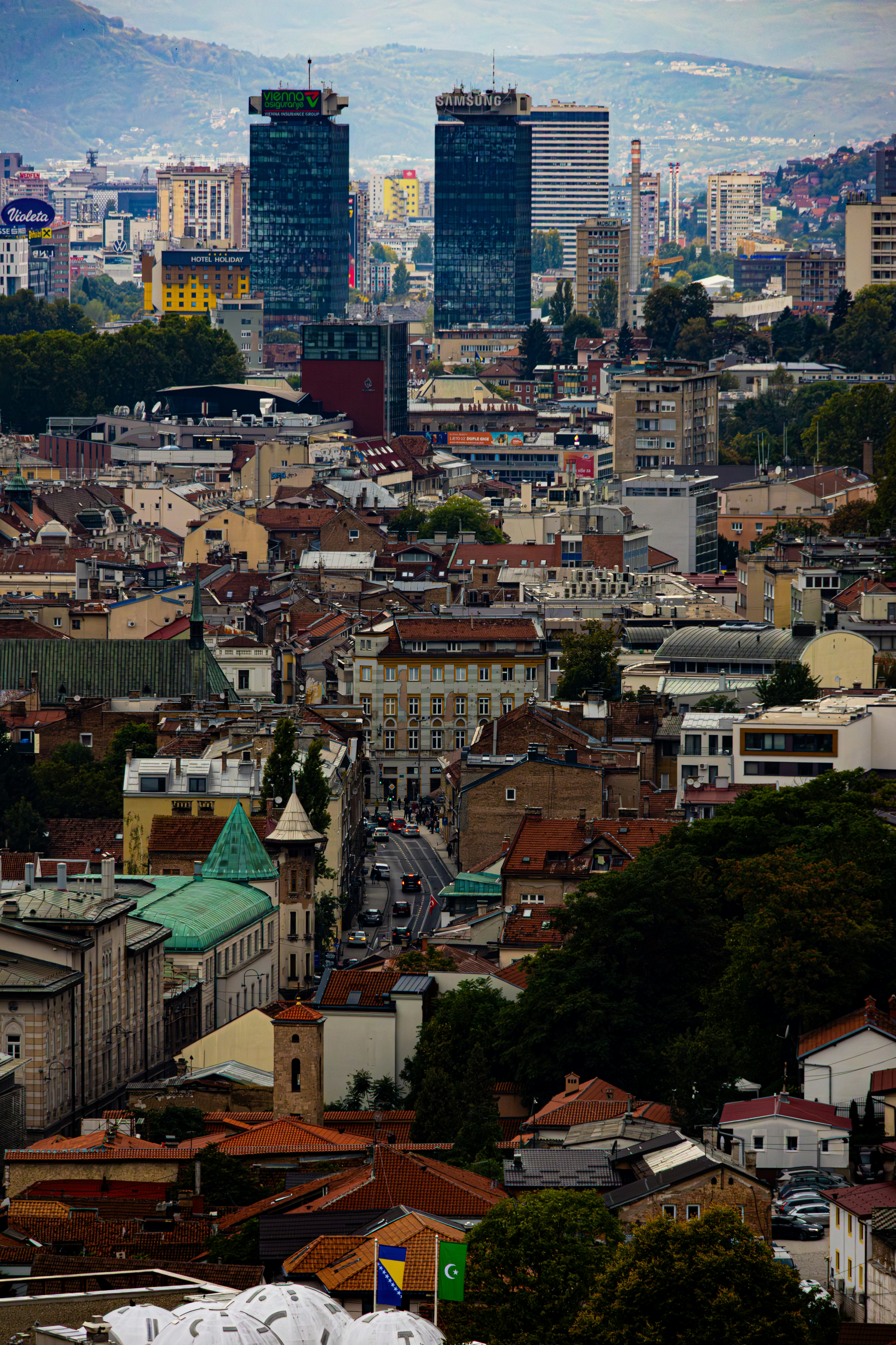 Tall modern buildings rise above a dense cityscape.