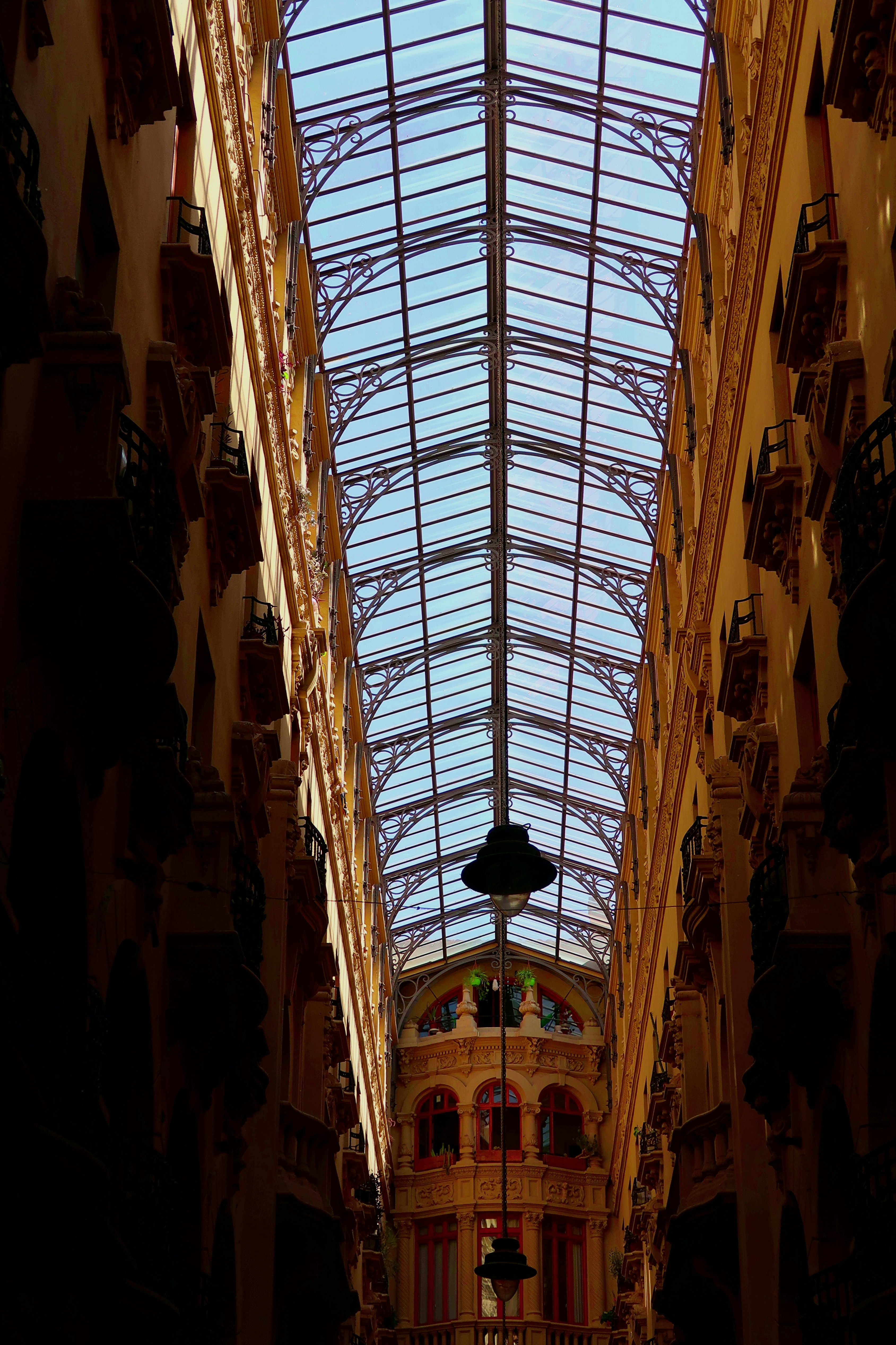 Skyward Glass Atrium: Converging Lines in a Golden Arcade