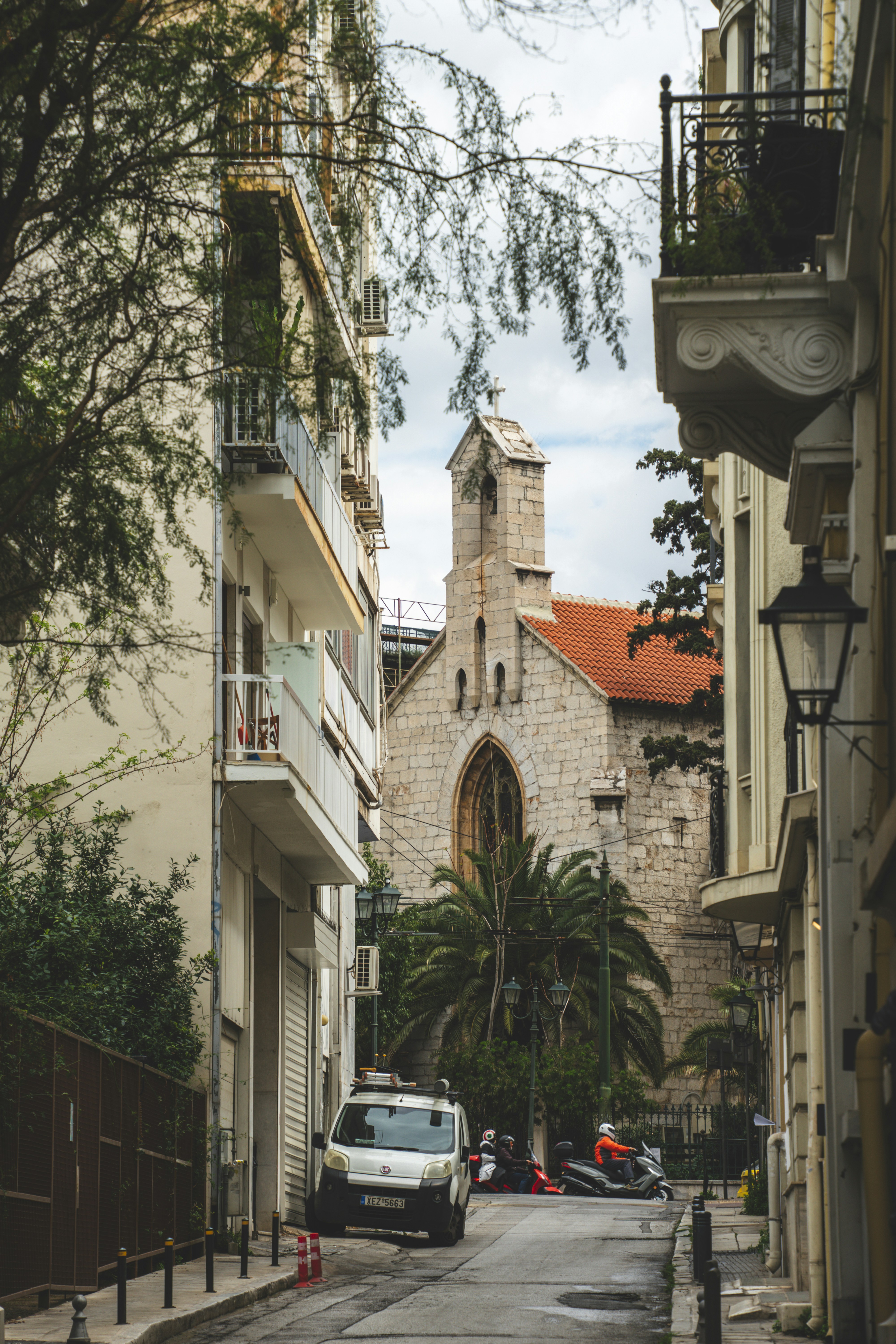 Path to the Stone Chapel: Palm-Framed Street in Golden Light