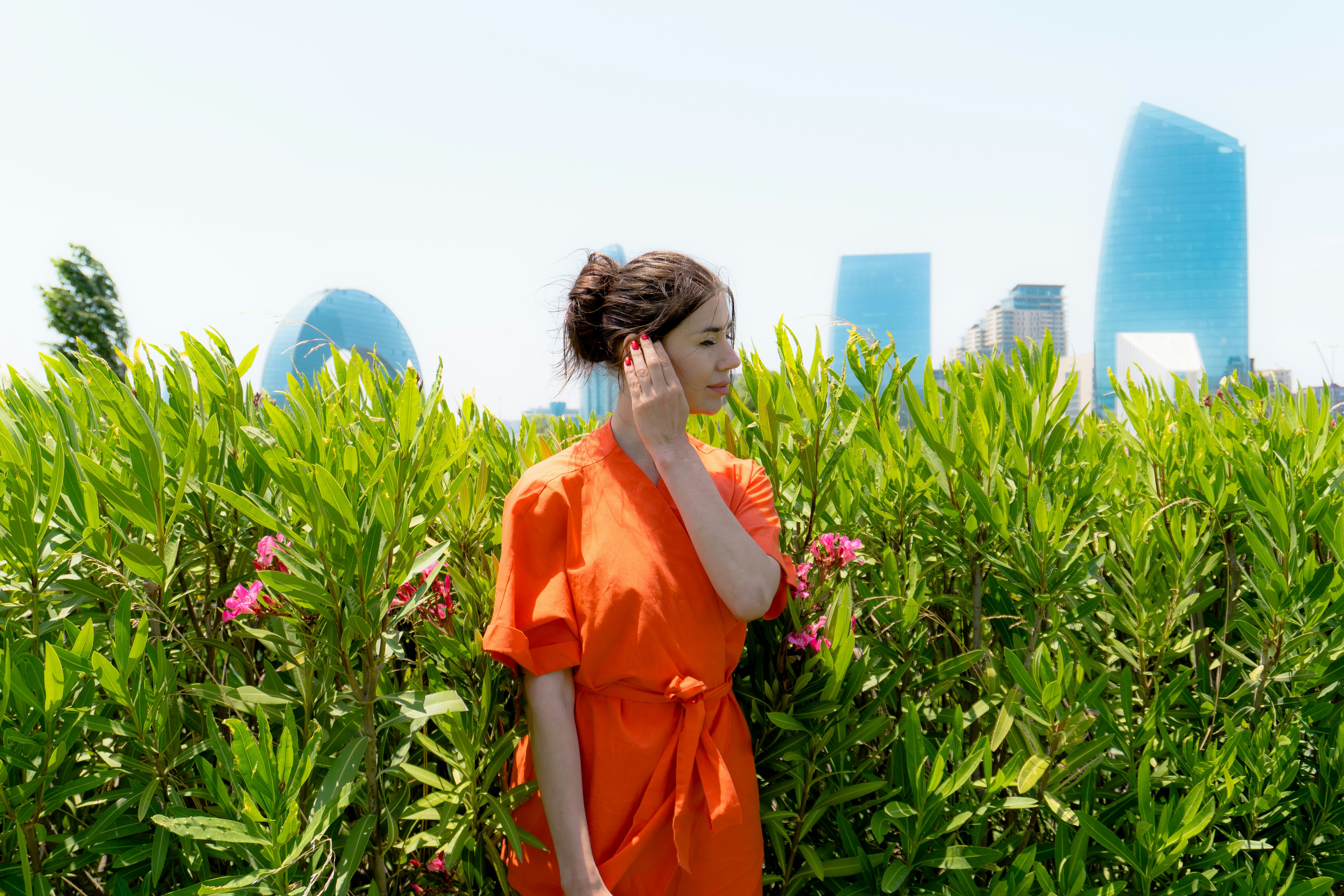 Orange in the Green: Portrait With a Glass Skyline Backdrop