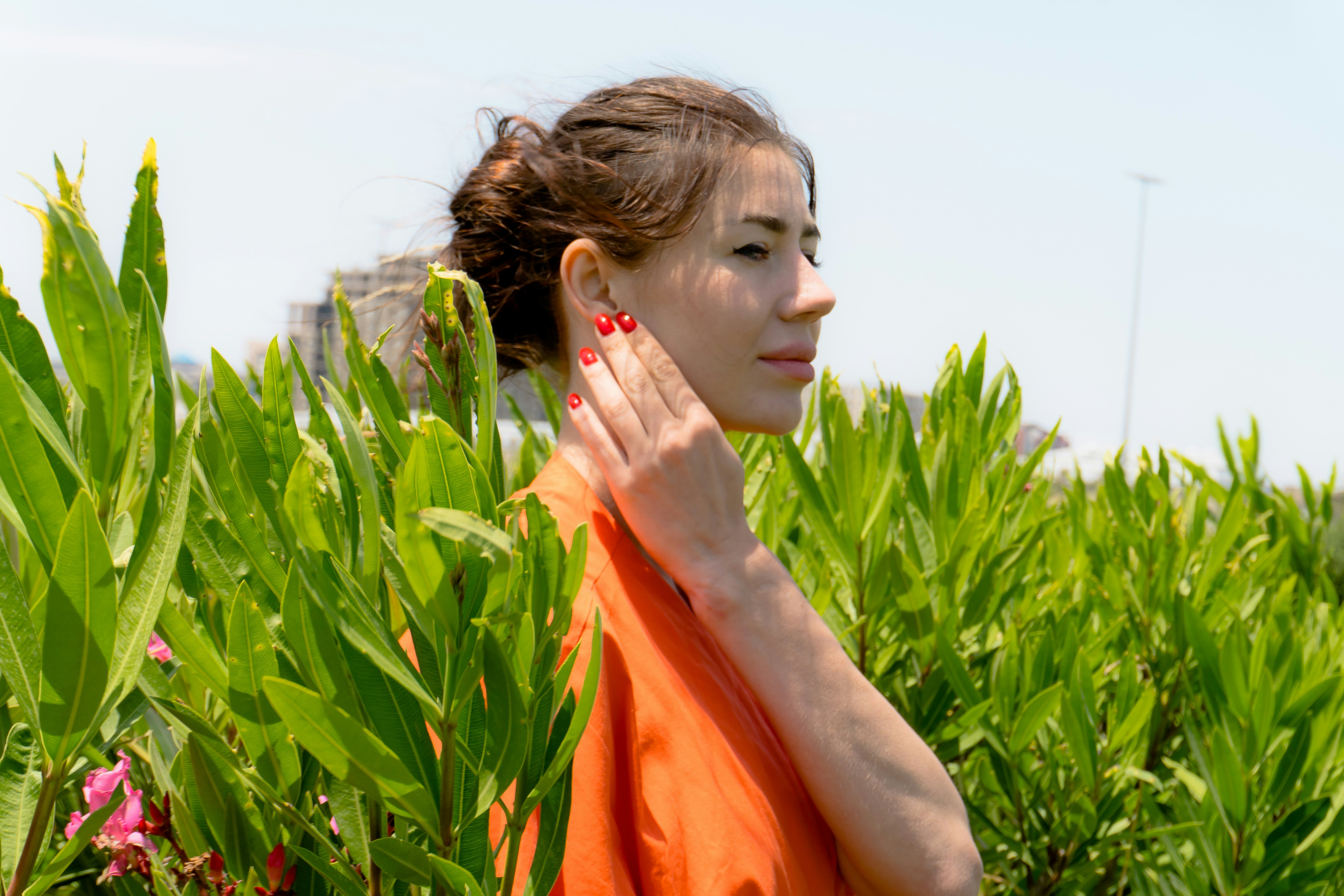 Amber Top in a Green Corridor: A Quiet Daylight Portrait