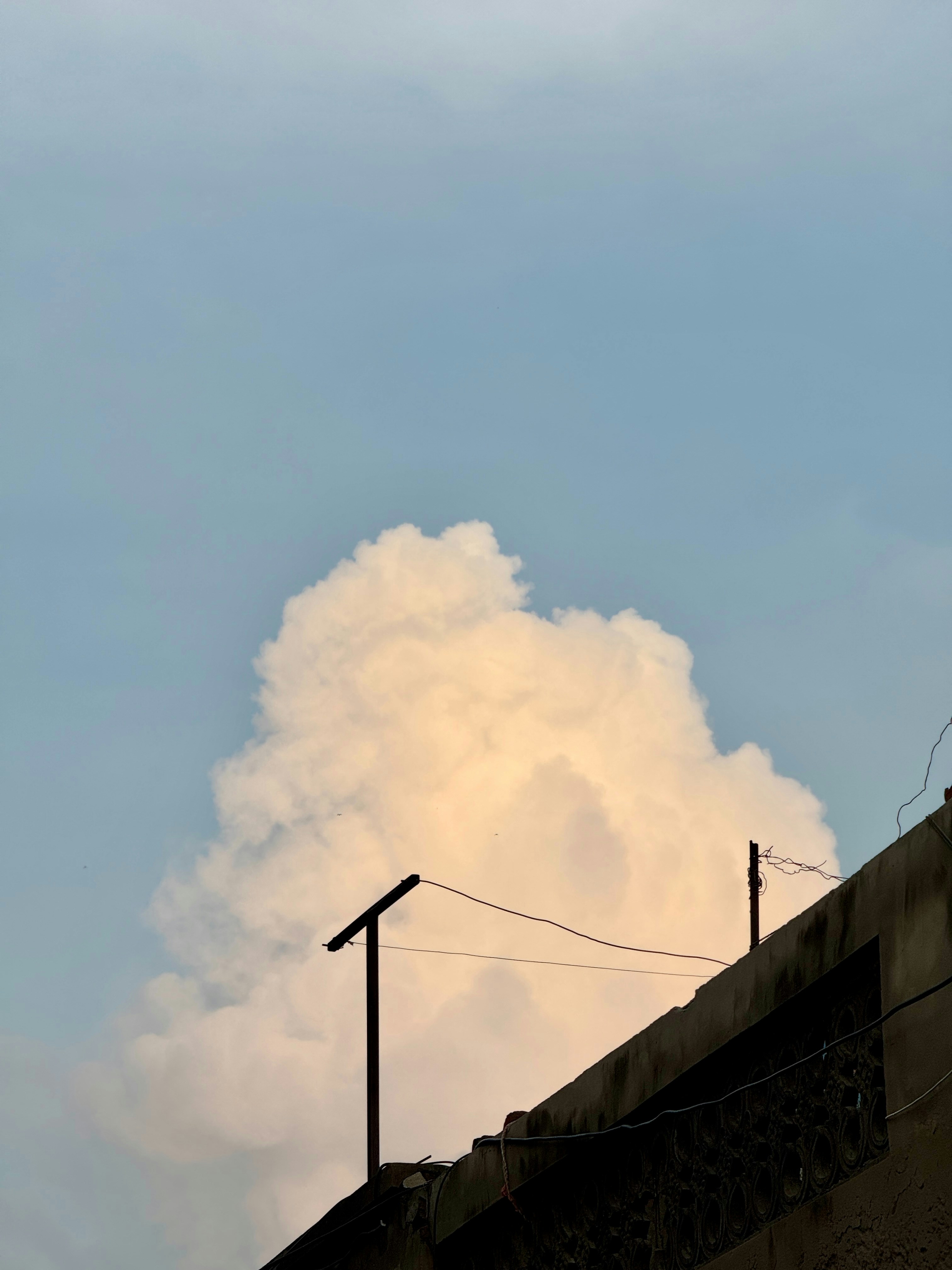 A large fluffy cloud against a blue sky.