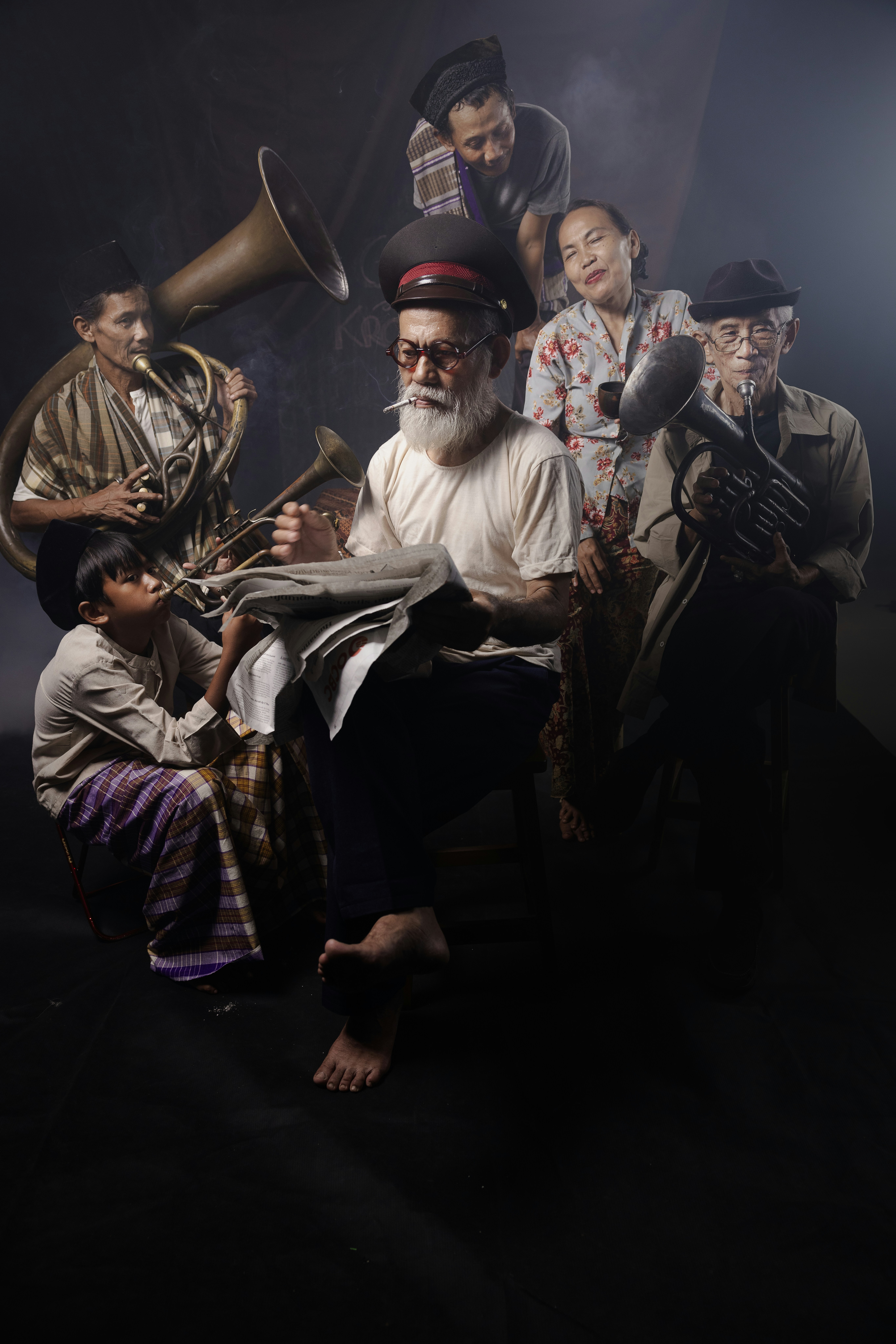 A multi-generational family posing with musical instruments.