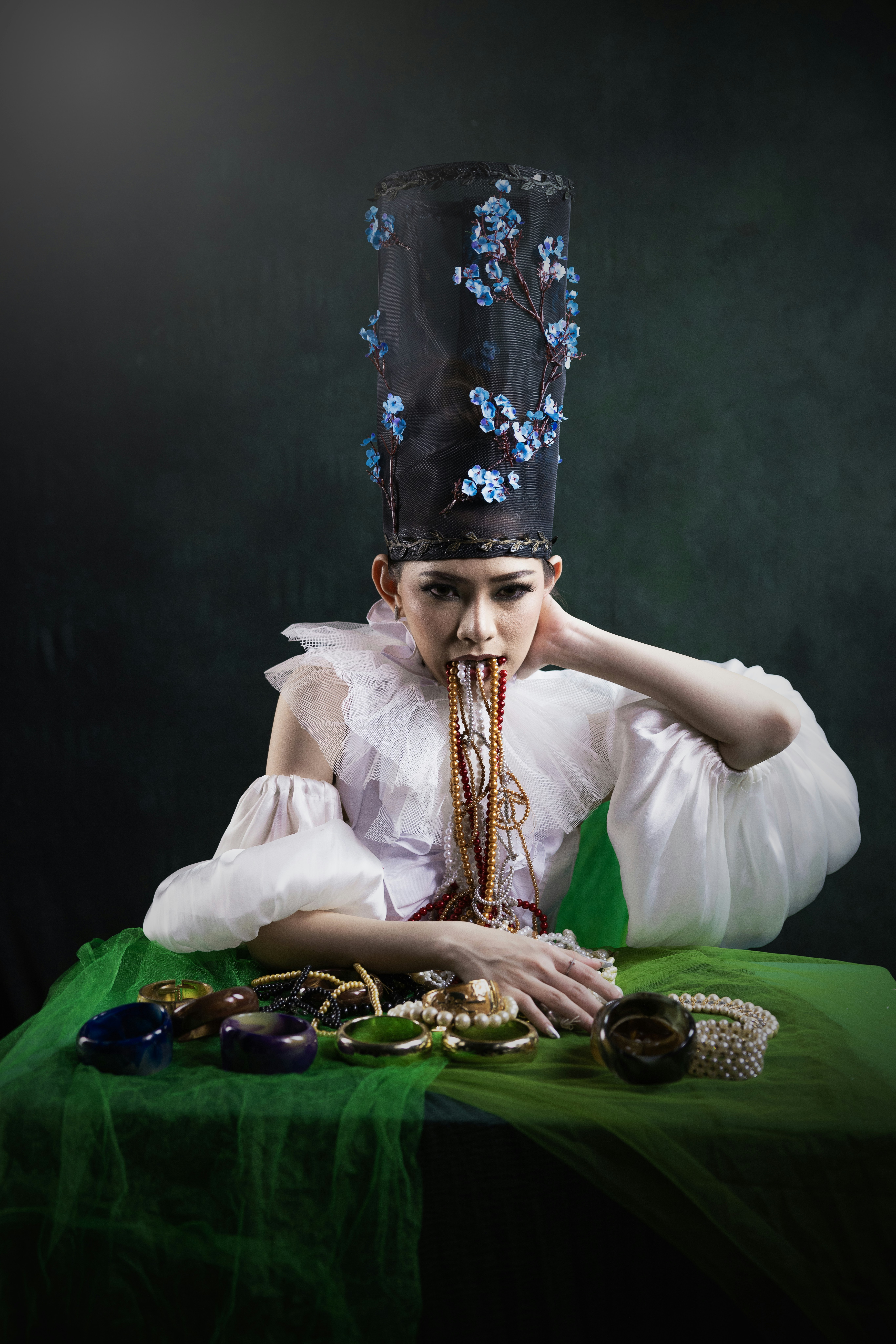 A figure adorned with a floral headdress and intricate jewelry, exuding an aura of mystery and artistry. The vibrant colors and textures create a striking visual narrative.