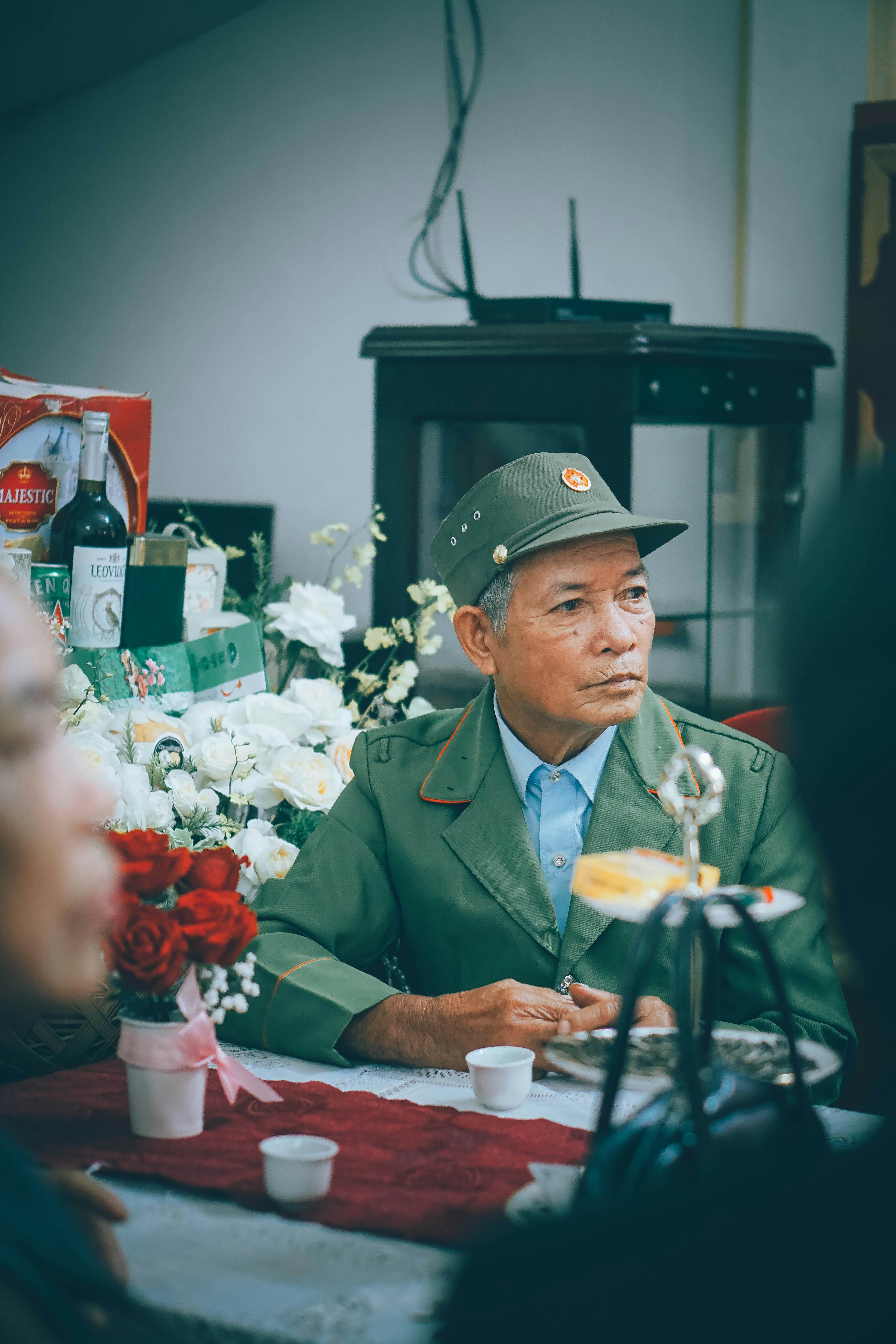 Elderly man in military uniform at a formal gathering