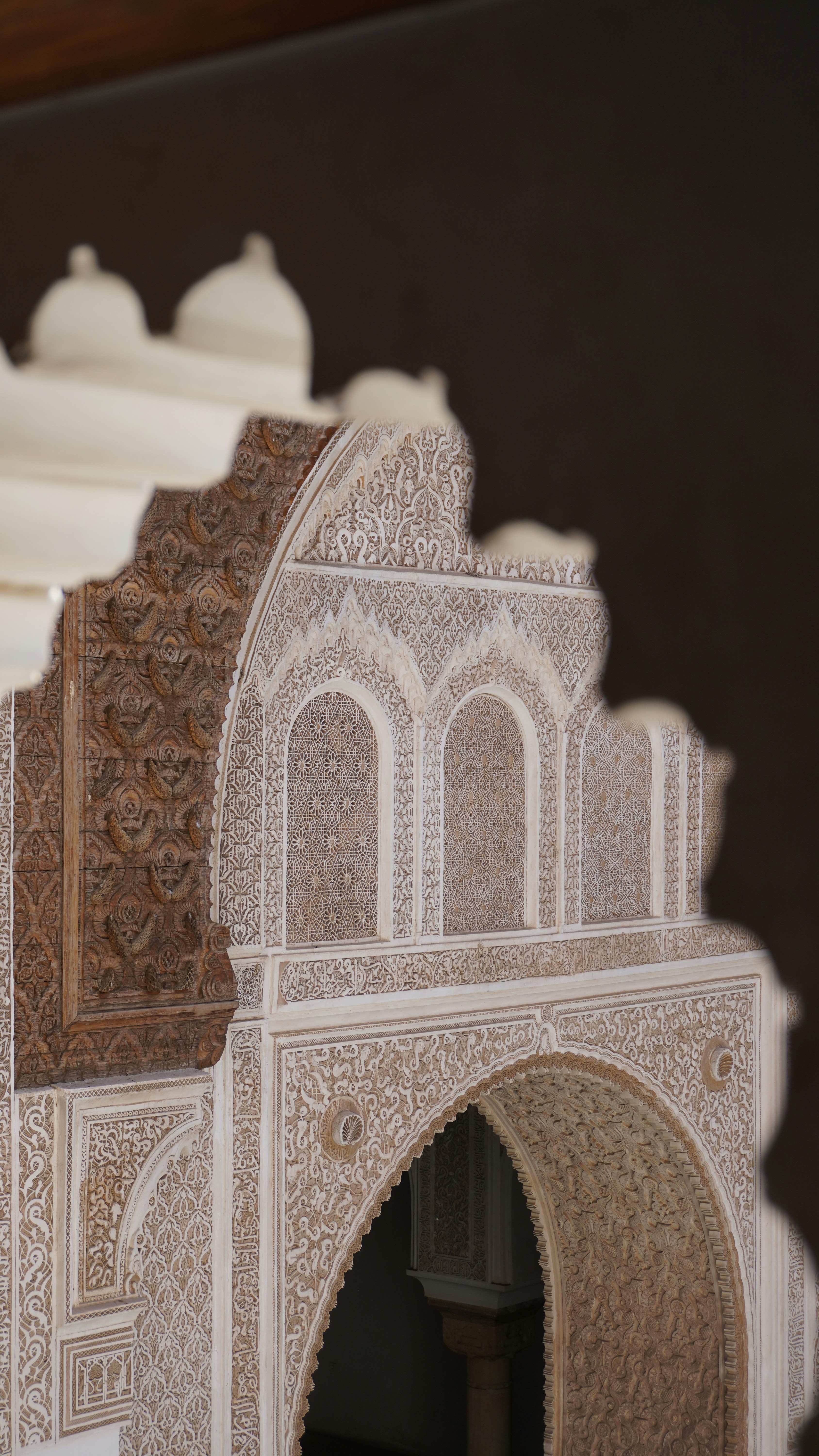 Lace-Patterned Portal: Sunlit Archway of Moorish Carvings