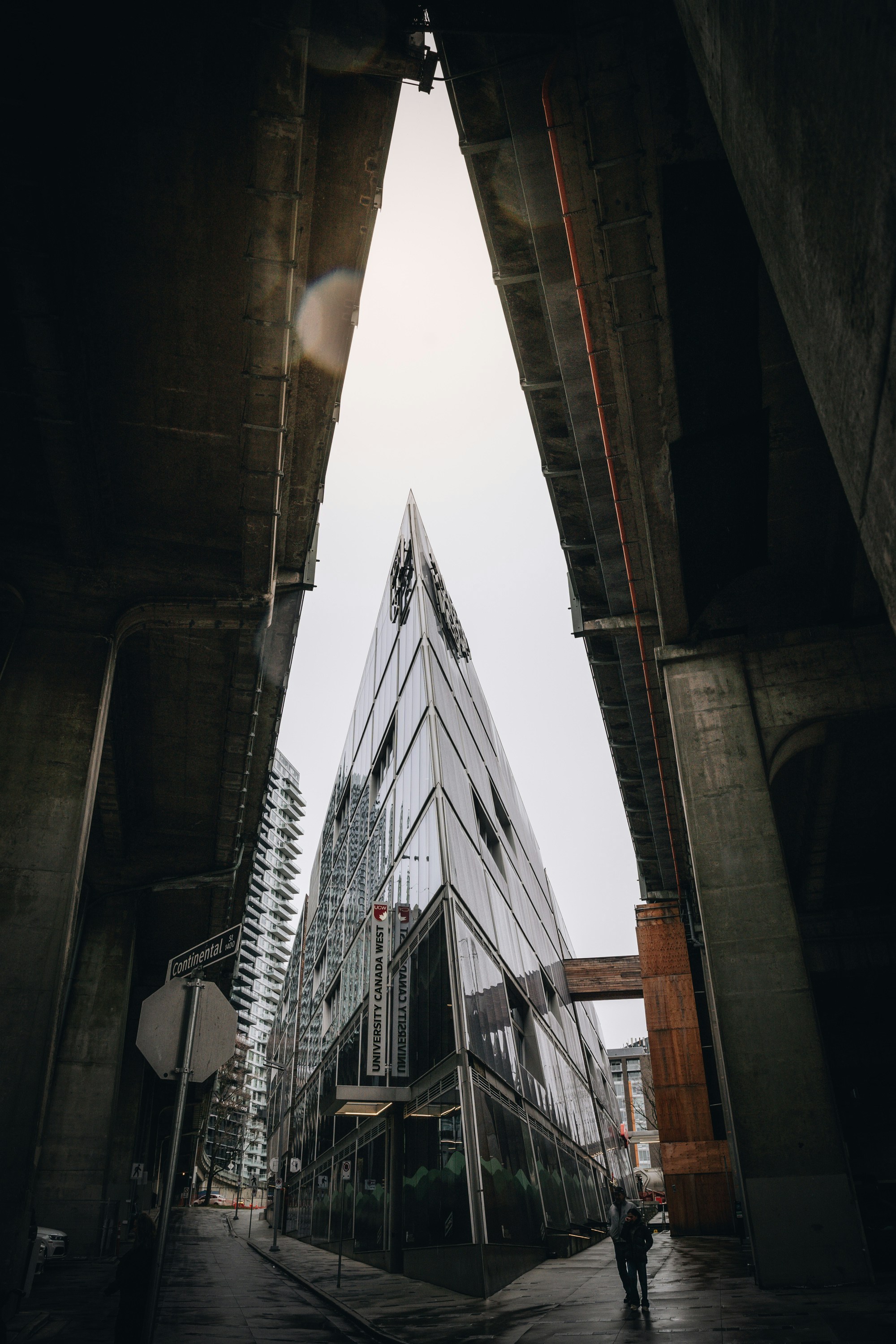 Between Giants: The Glass Arrow Piercing a City Canyon