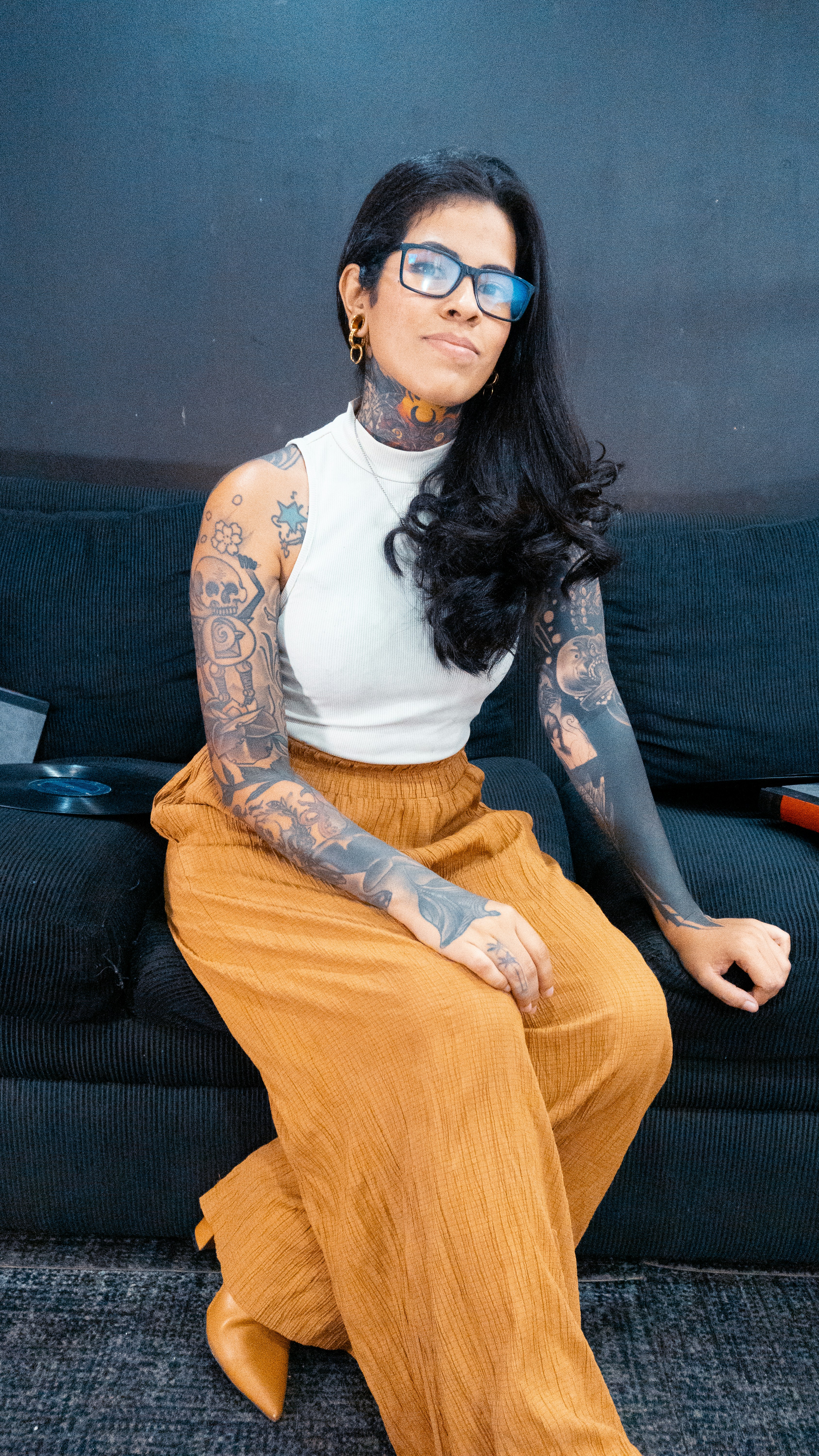 Ink & Velvet: Portrait of Confidence on a Dark Sofa