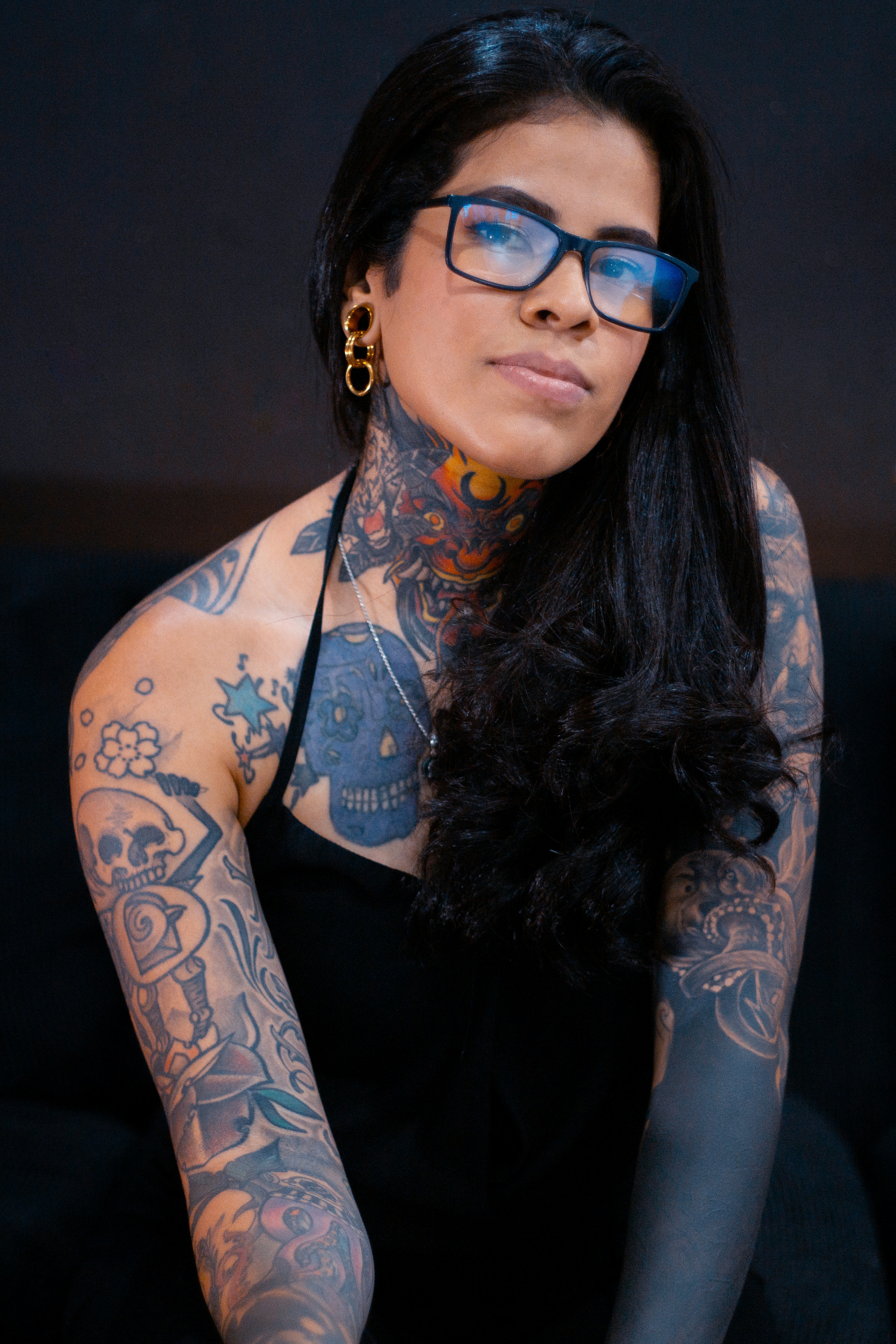 Ink and Blue: Portrait of a Tattooed Woman under Velvet Light