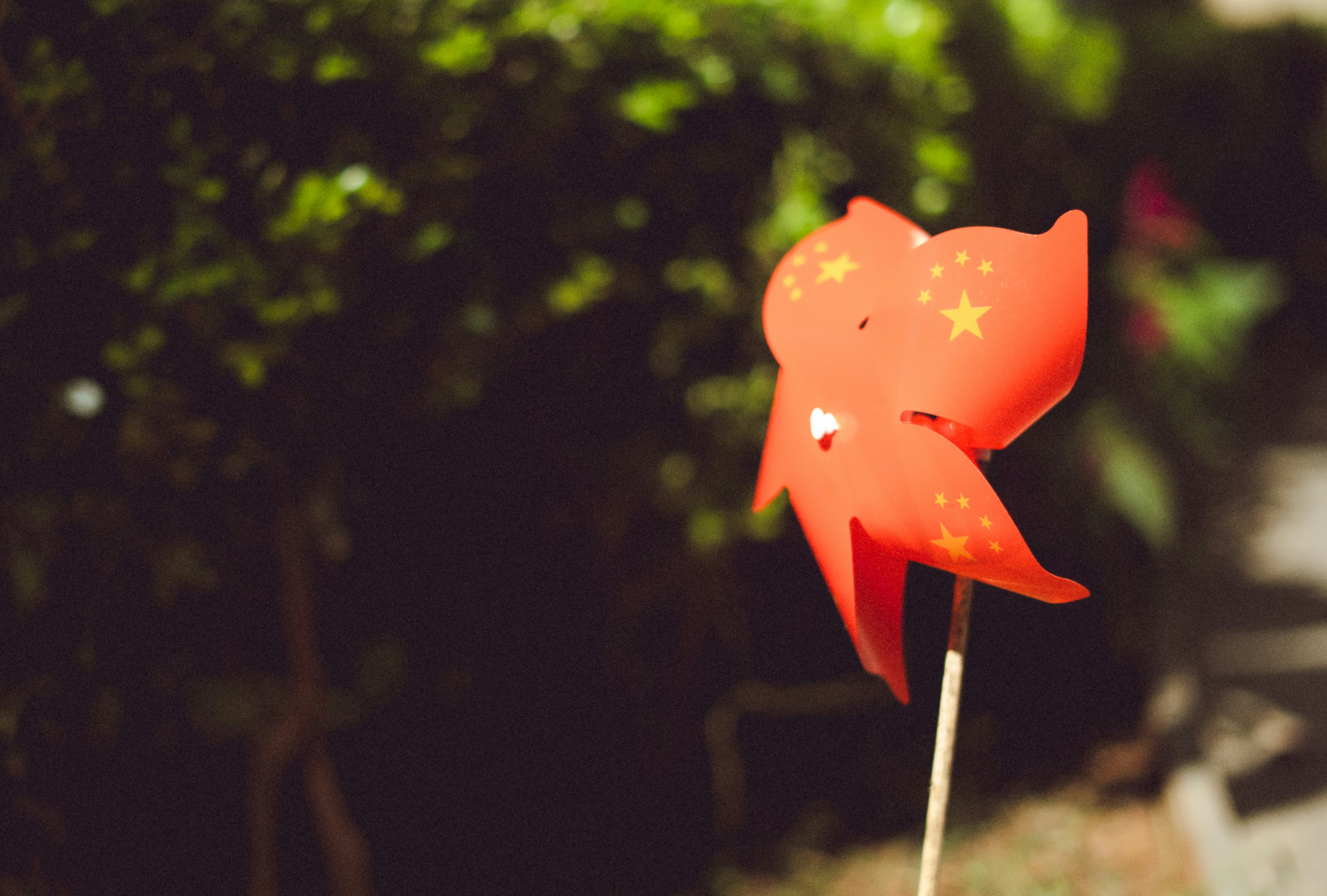 Red pinwheel with yellow stars outdoors