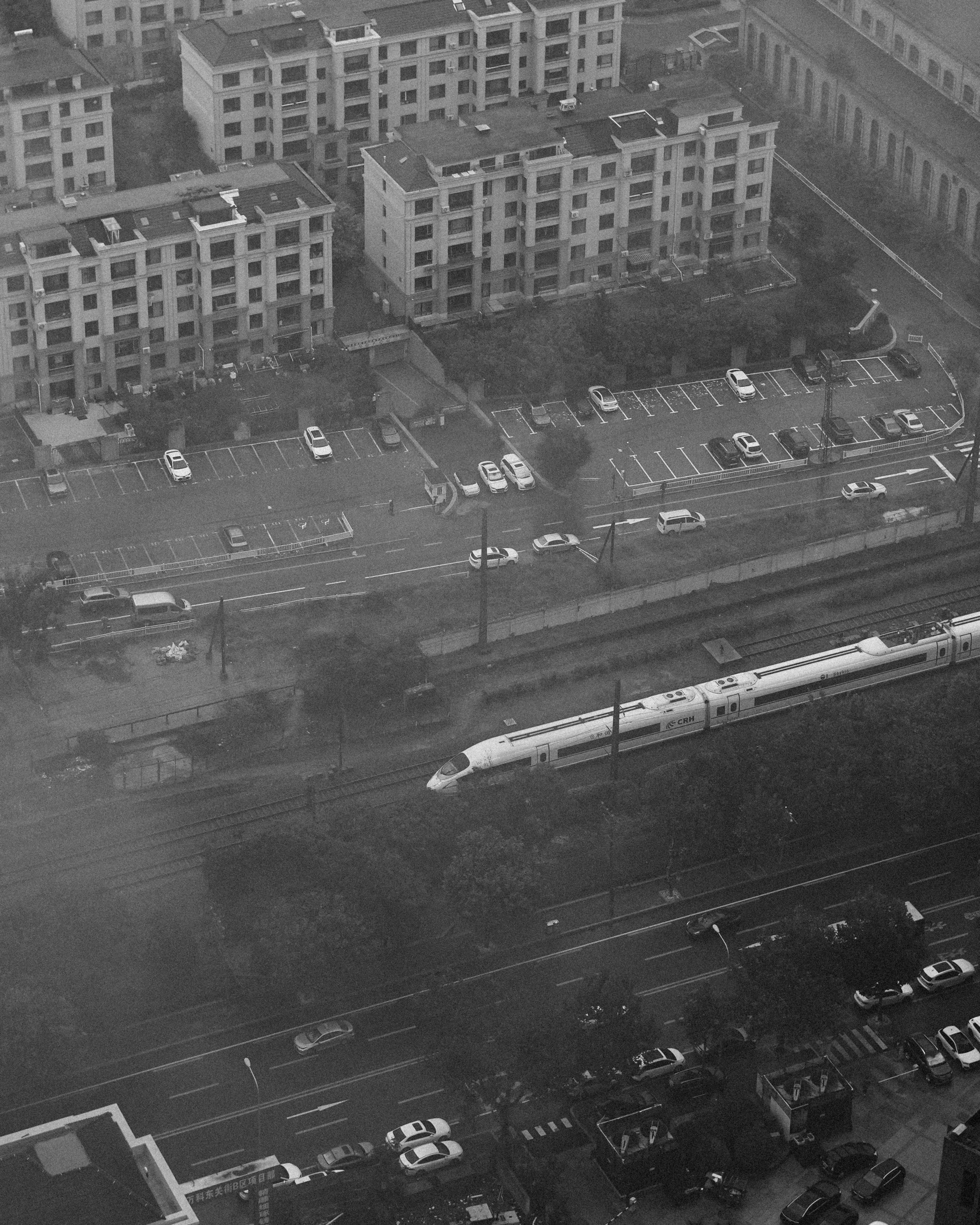High-angle view of a train passing by buildings.