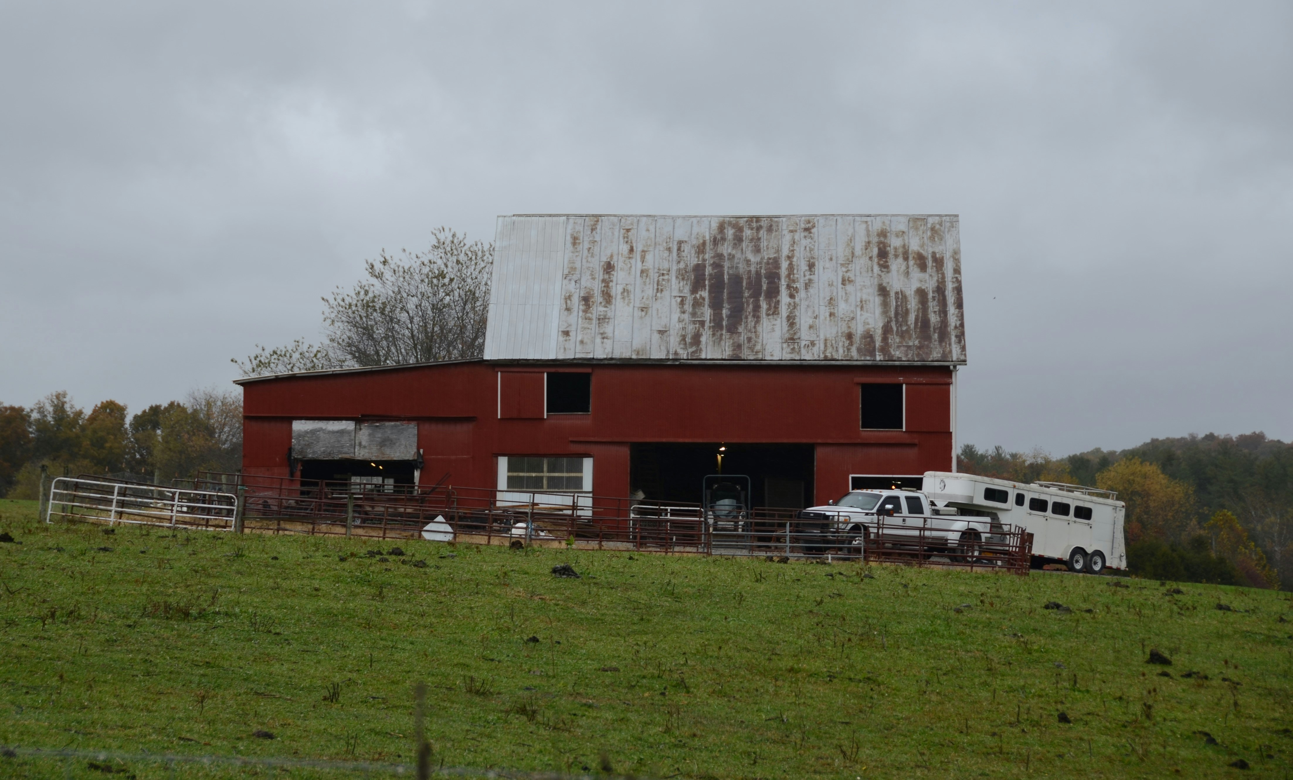 Lead-gray Sky, Rusted Roof: The Red Barn's Quiet Farmyard