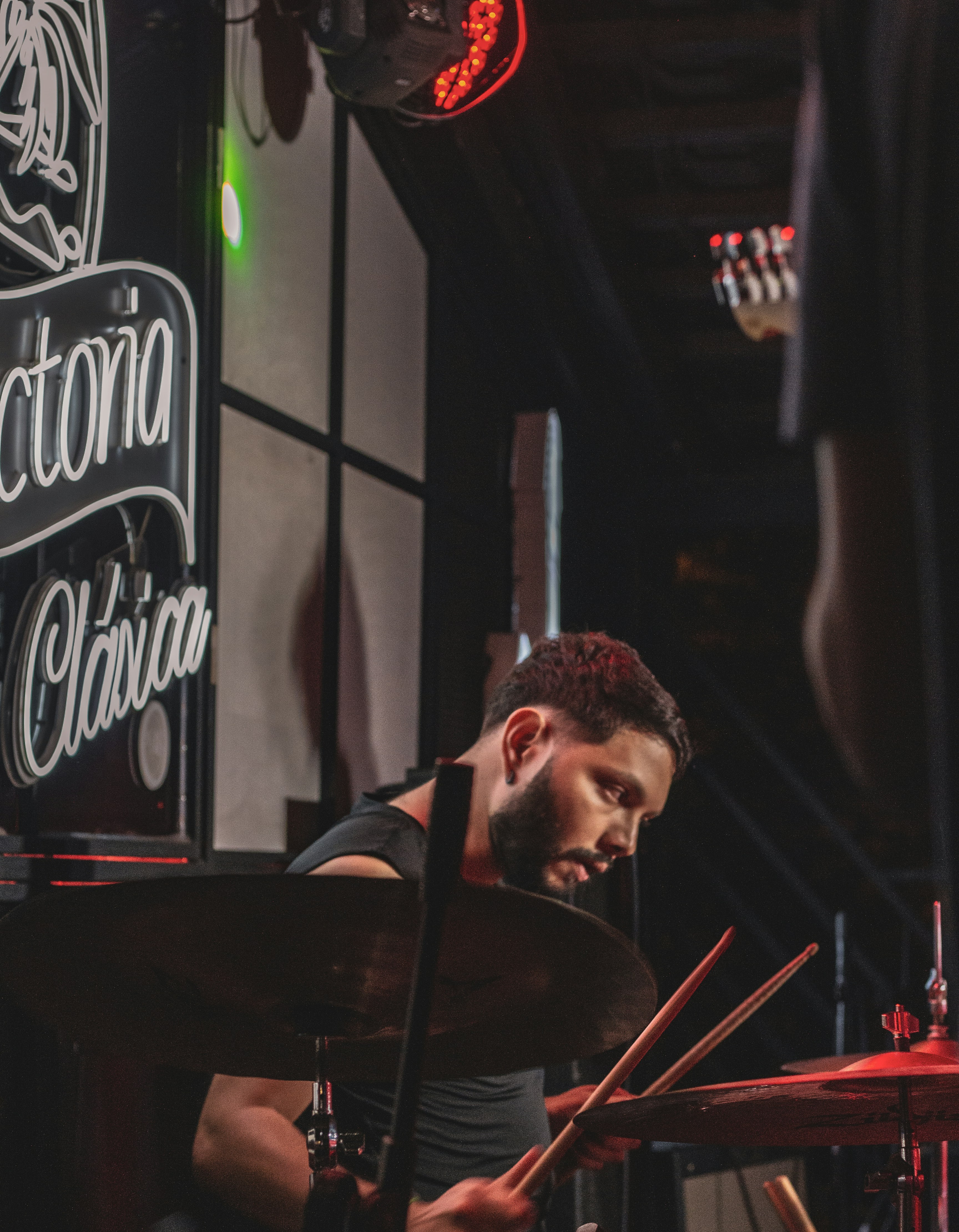 Neon-Glow Drummer in the Club's Quiet Spotlight