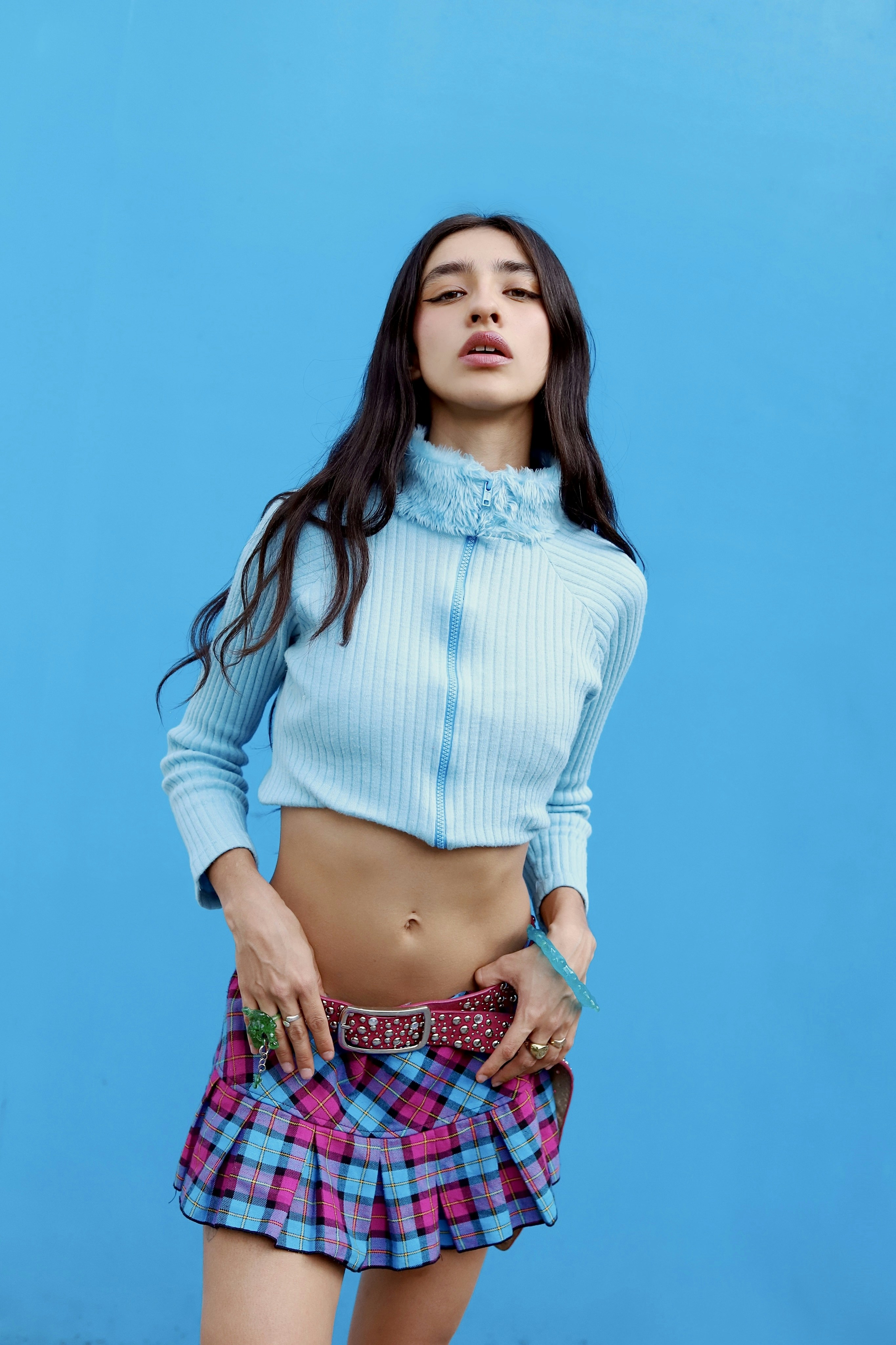 Azure Confidence: Portrait Against a Solid Blue Backdrop