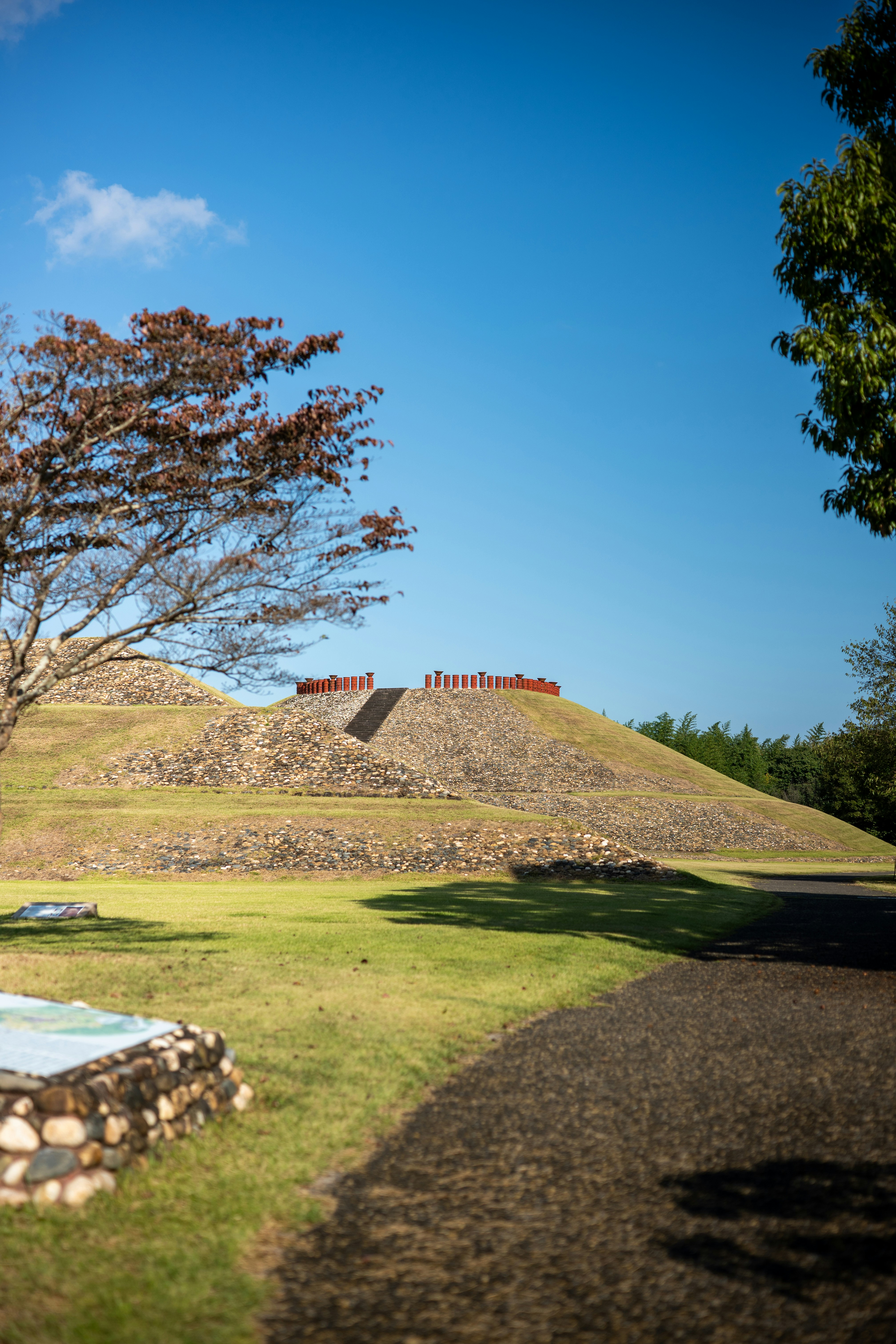 Ancient earthen mounds with red structures on top photo – Free Blue sky ...
