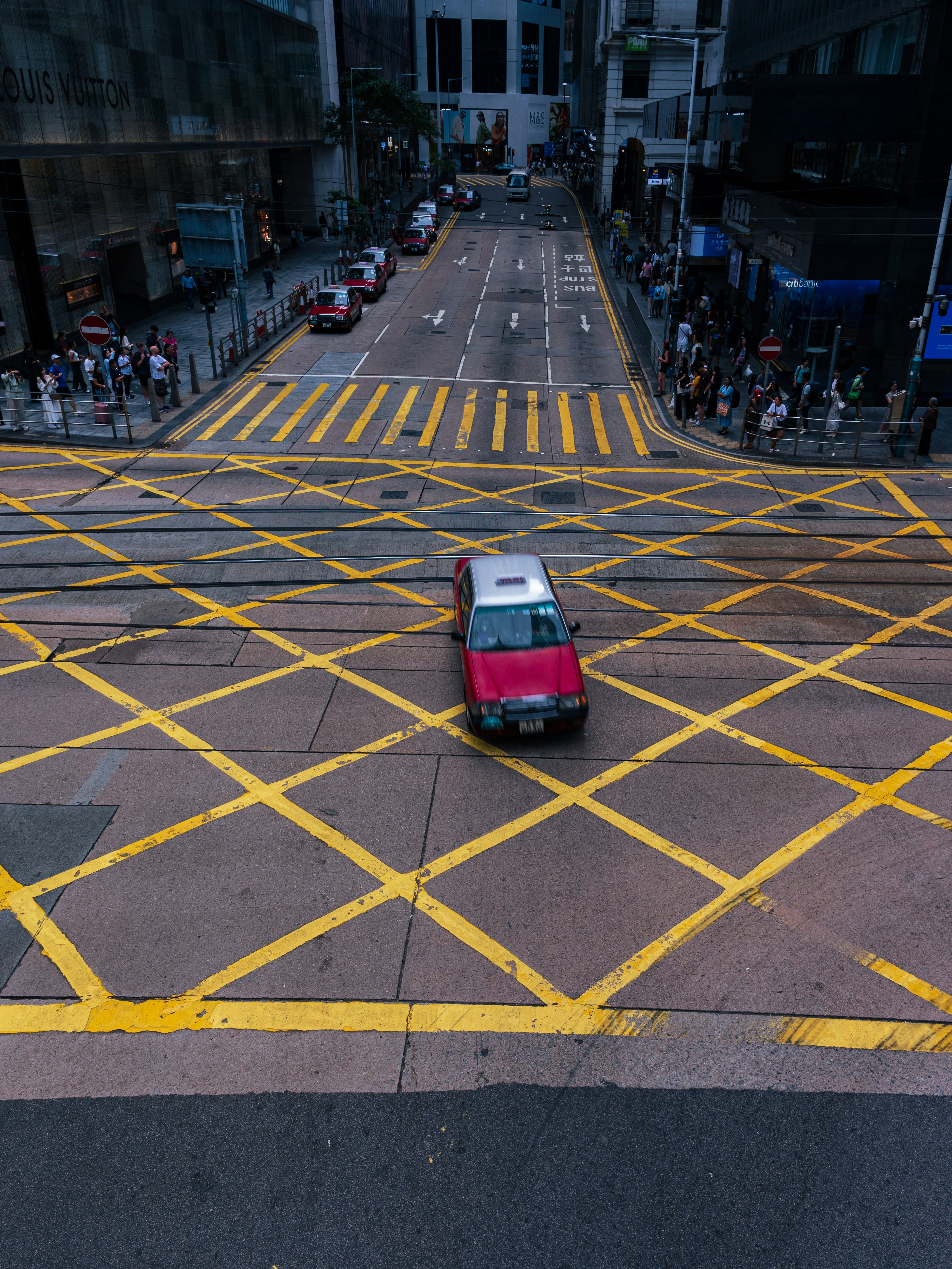 Crimson Taxi at the Heart of a Yellow City Grid