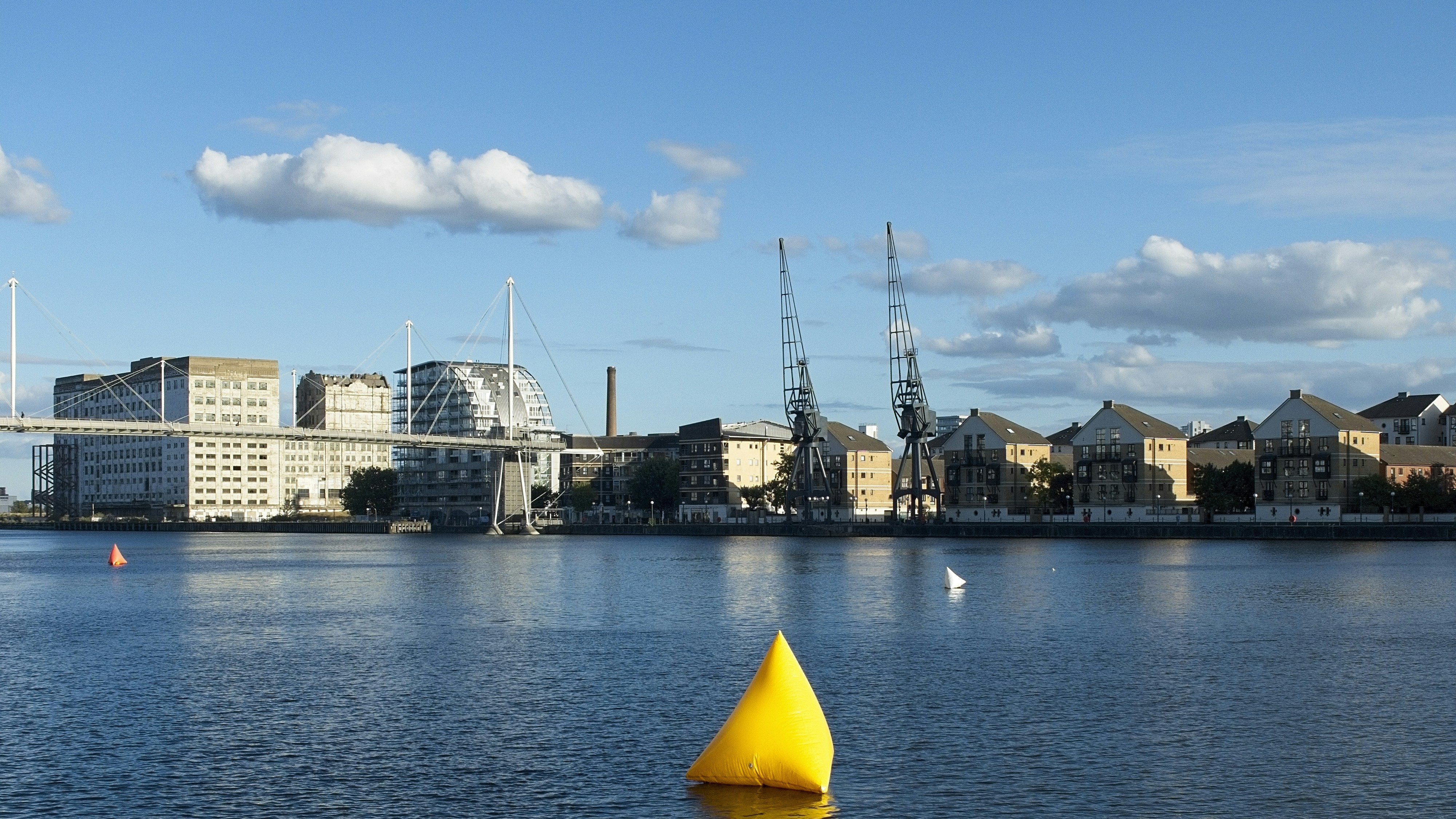 City skyline with a river and yellow buoy