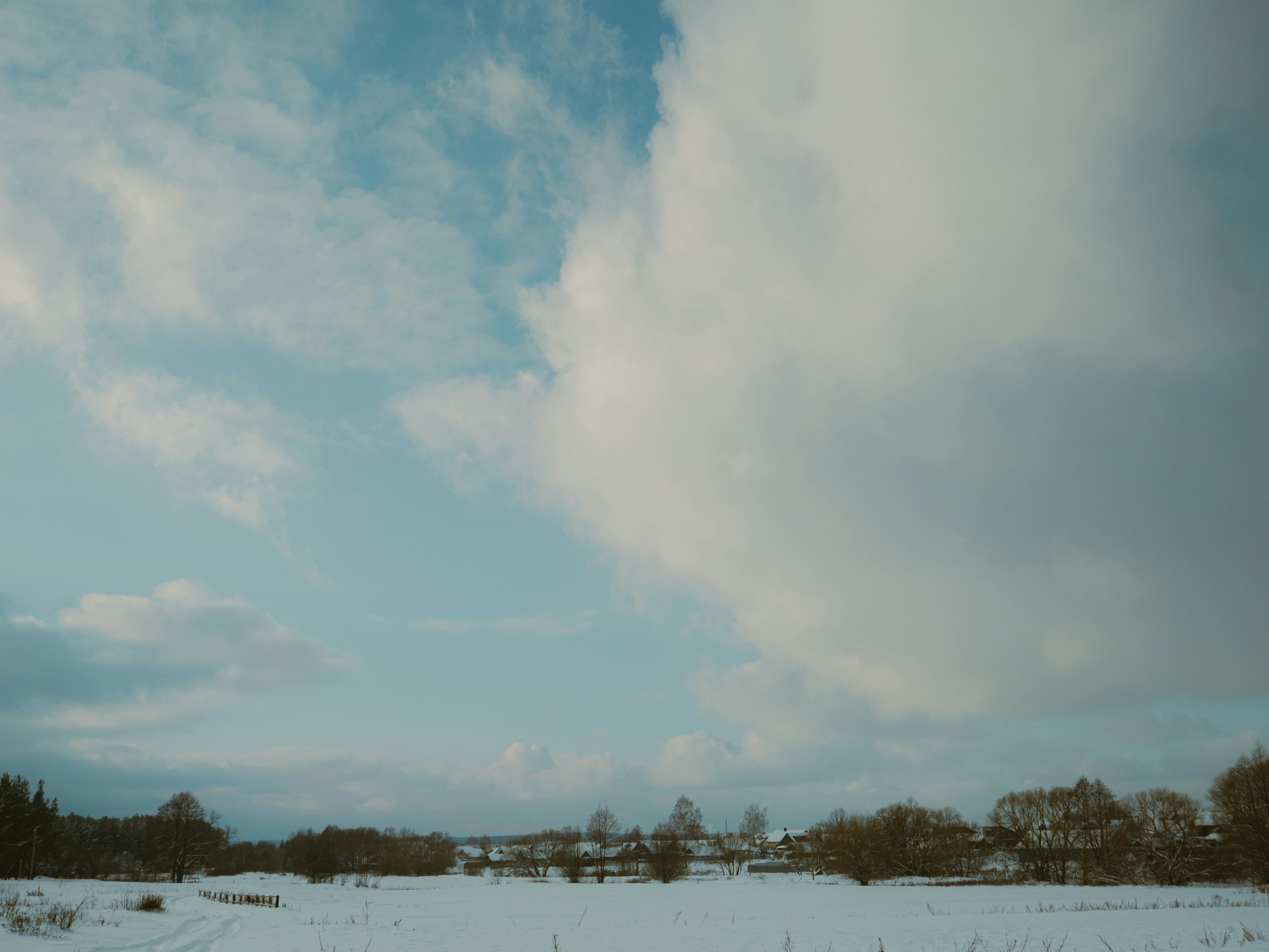 Winter landscape with snow and cloudy sky