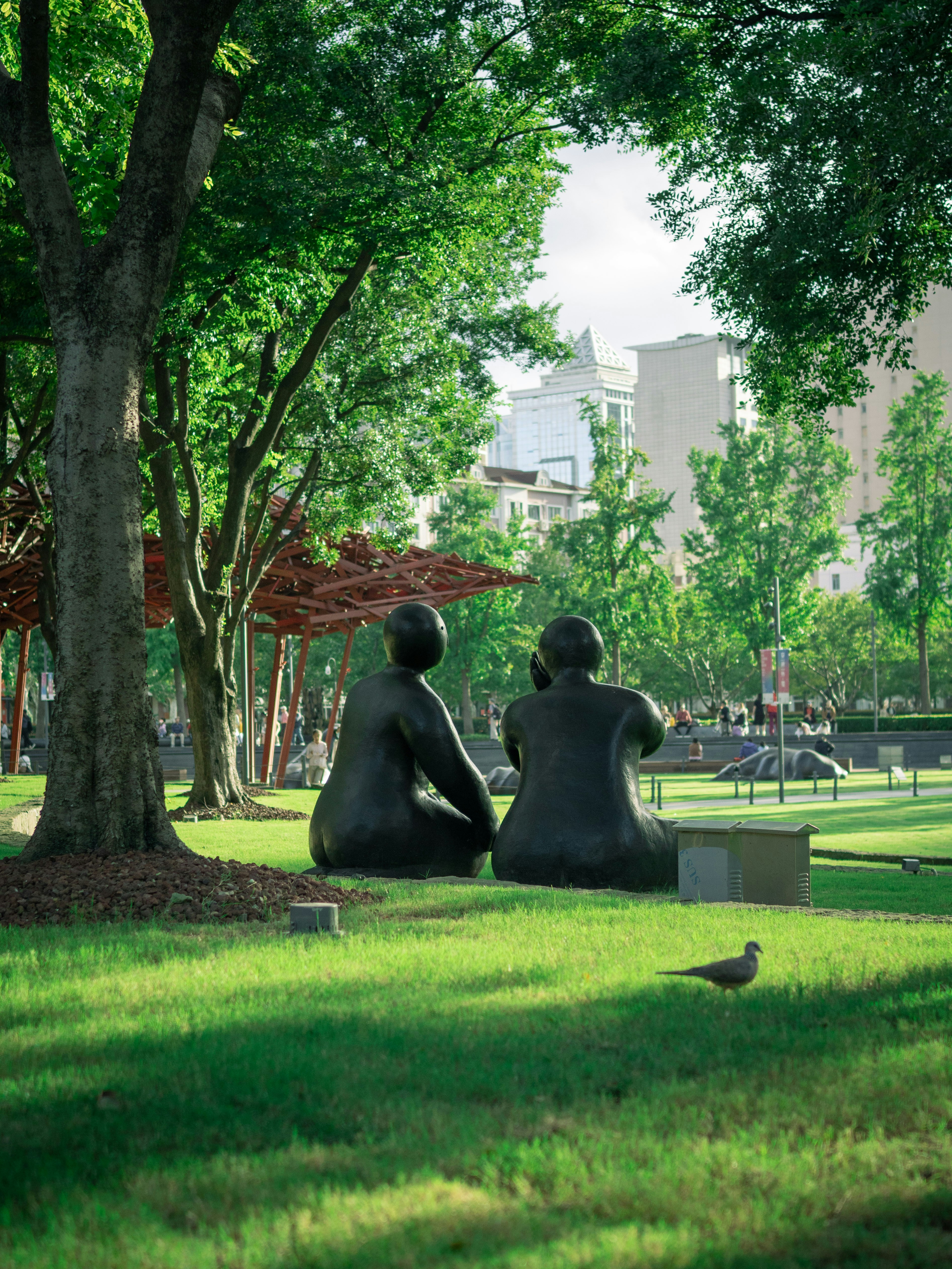 Two Bronze Companions in a Sunlit City Park