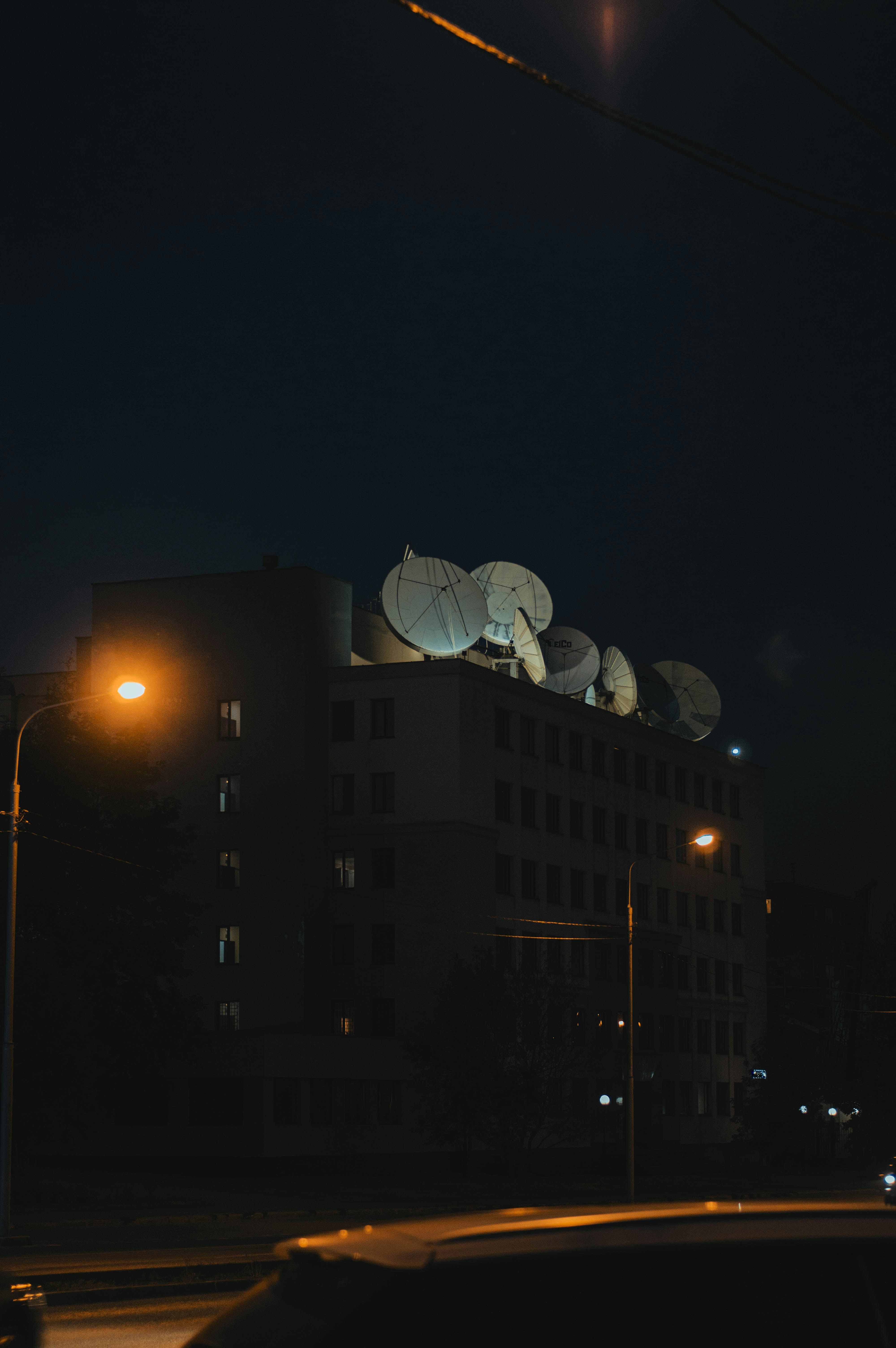 Satellite Dishes Under a Night Sky: A Quiet Urban Roofscape
