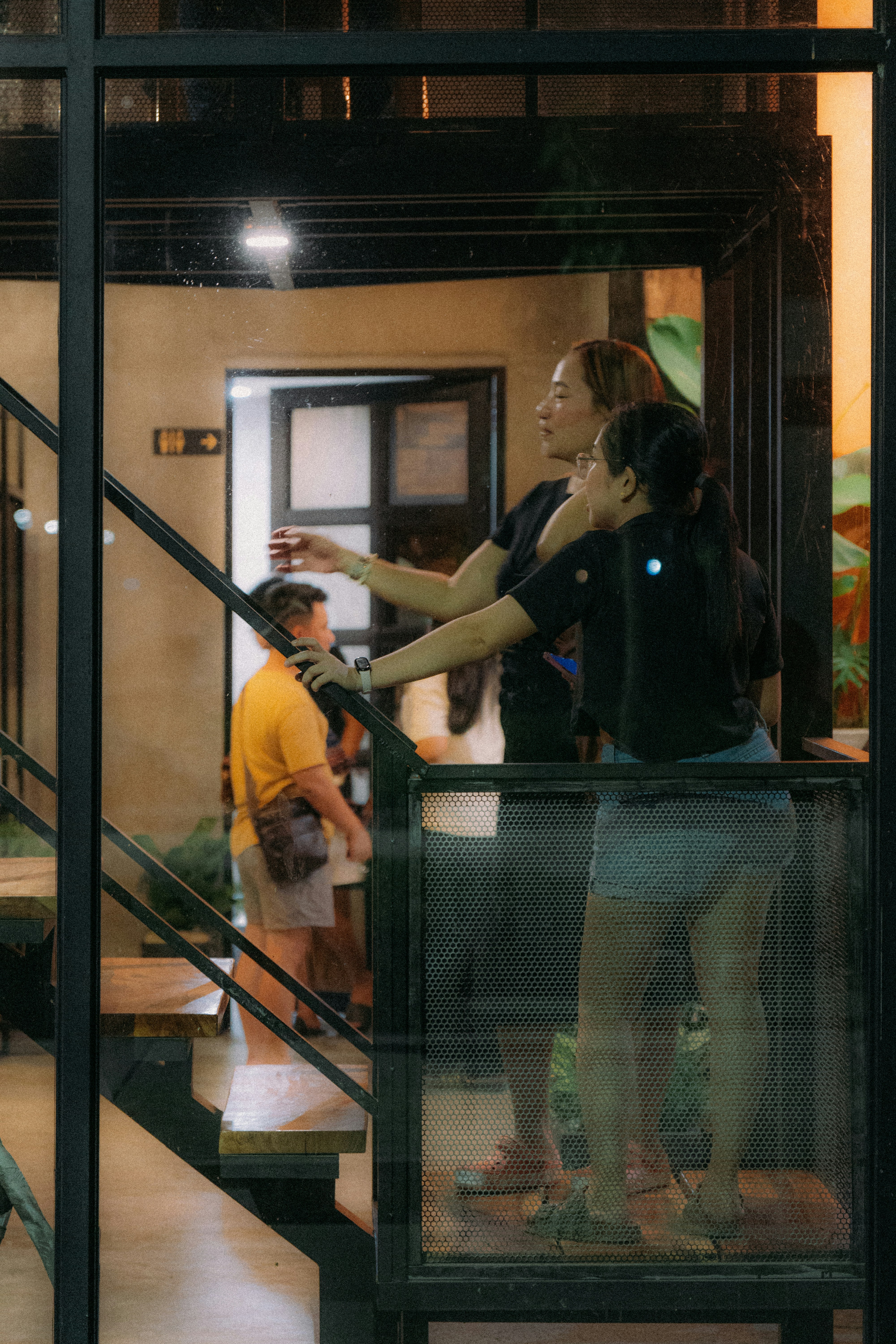 Glass-Fronted Stairwell Whispers: Nighttime Conversations by the Railing