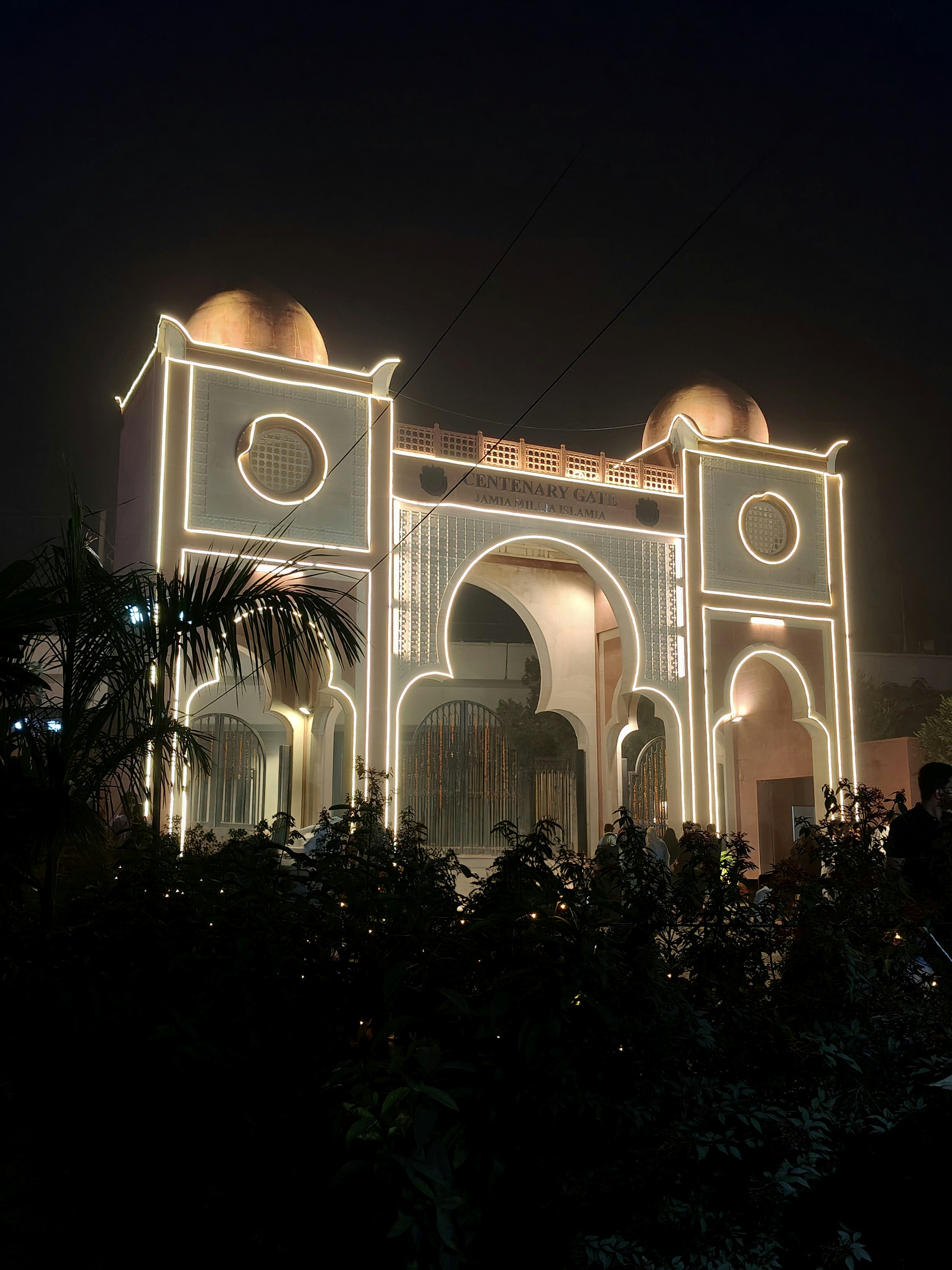 Neon Archway at Night: Illuminated Circles Framing a Quiet Gateway