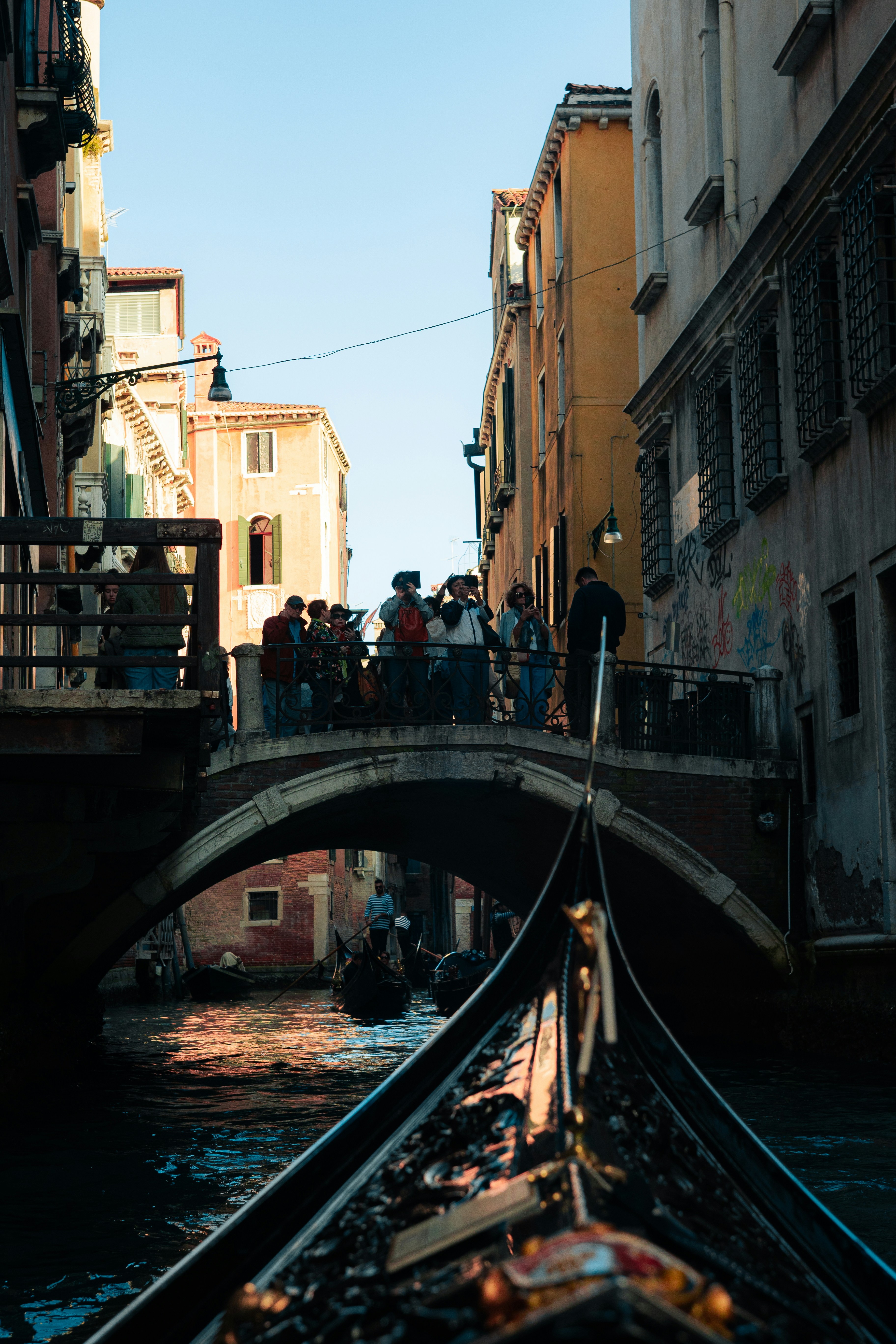 Crowd on a Venetian Bridge: Sunlit Faces Above the Canal