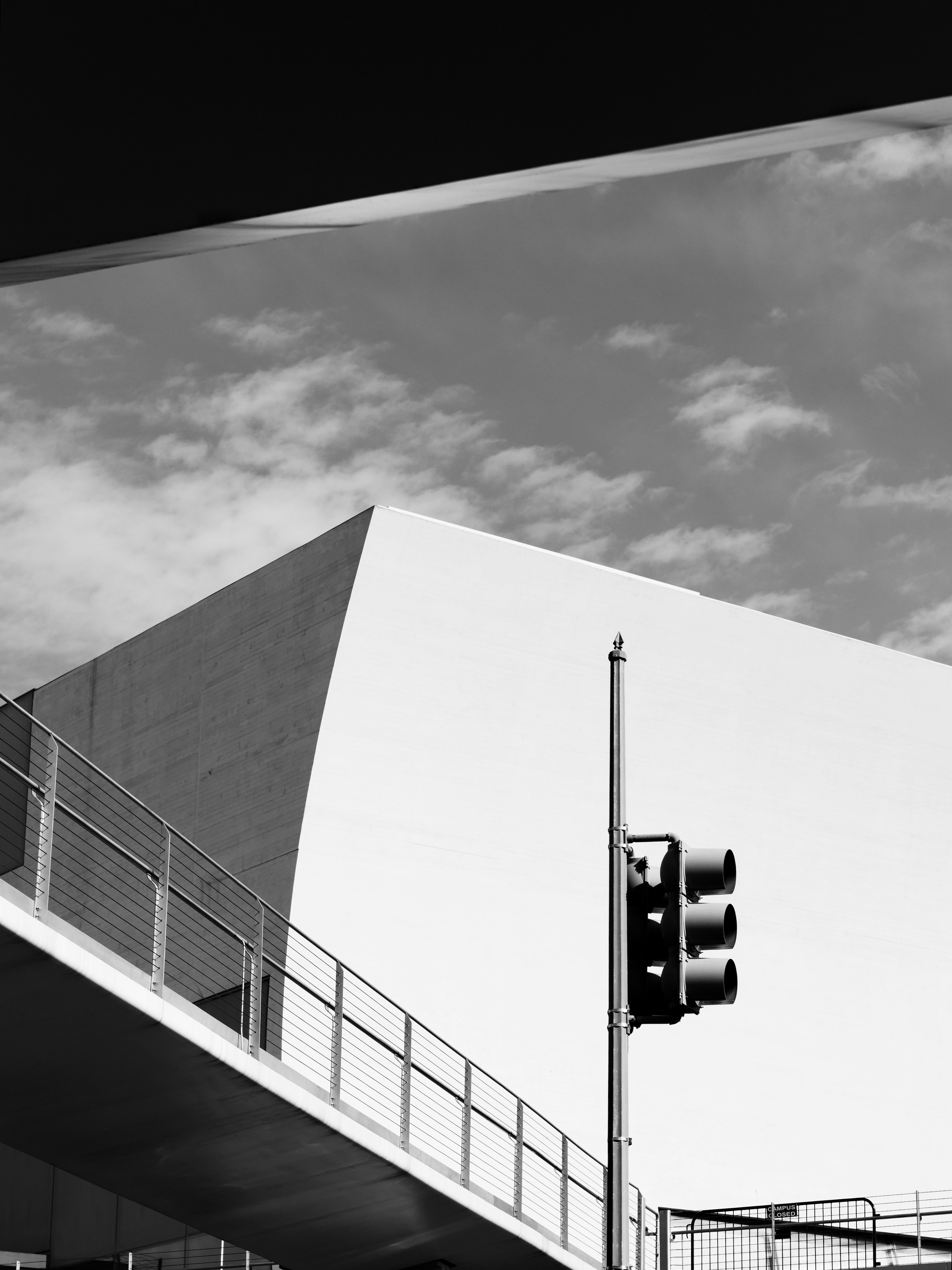 Monochrome Angles: A Diagonal Ramp Framing a Traffic Signal