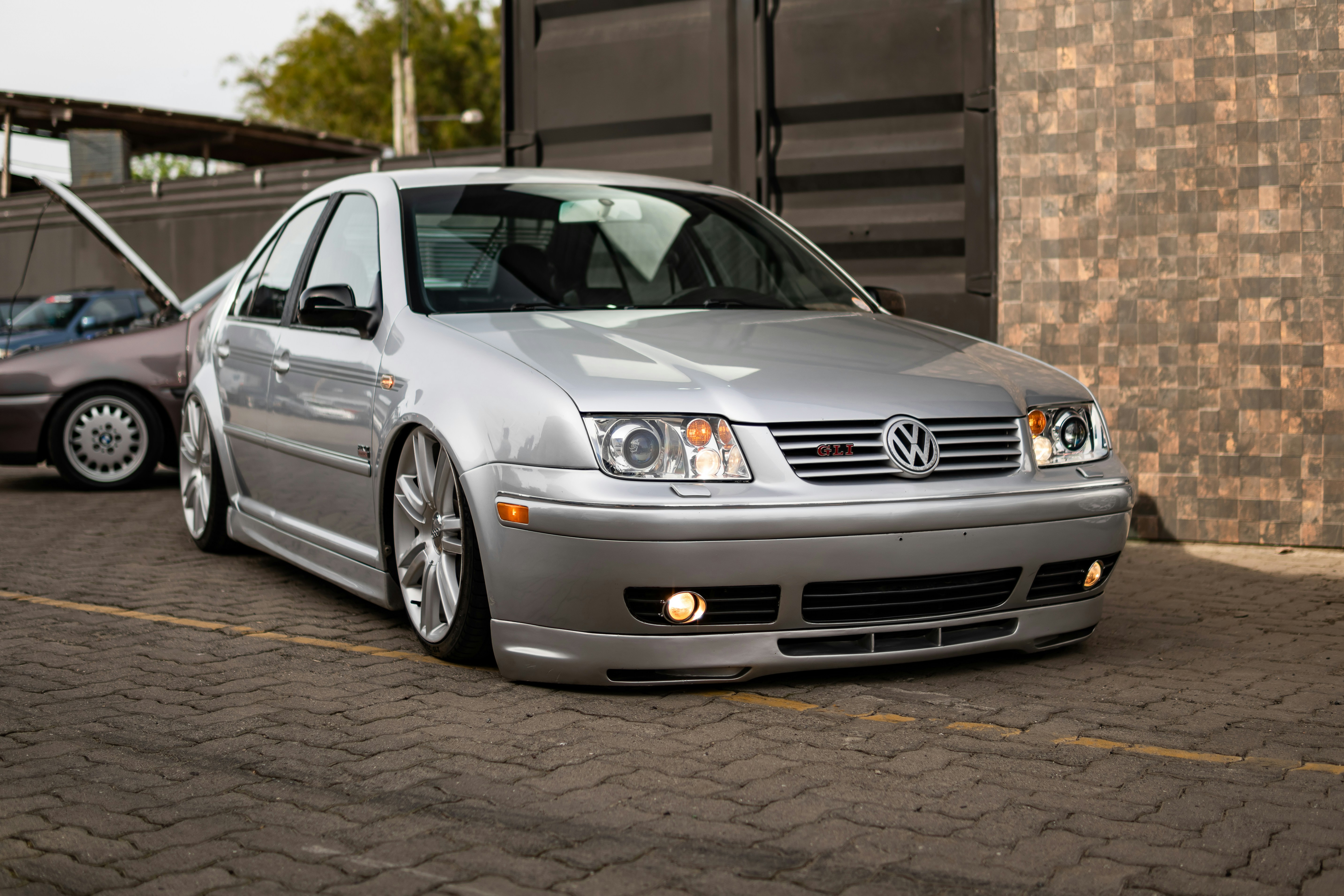 Stance in the City: A Lowered Silver Volkswagen in Concrete Light