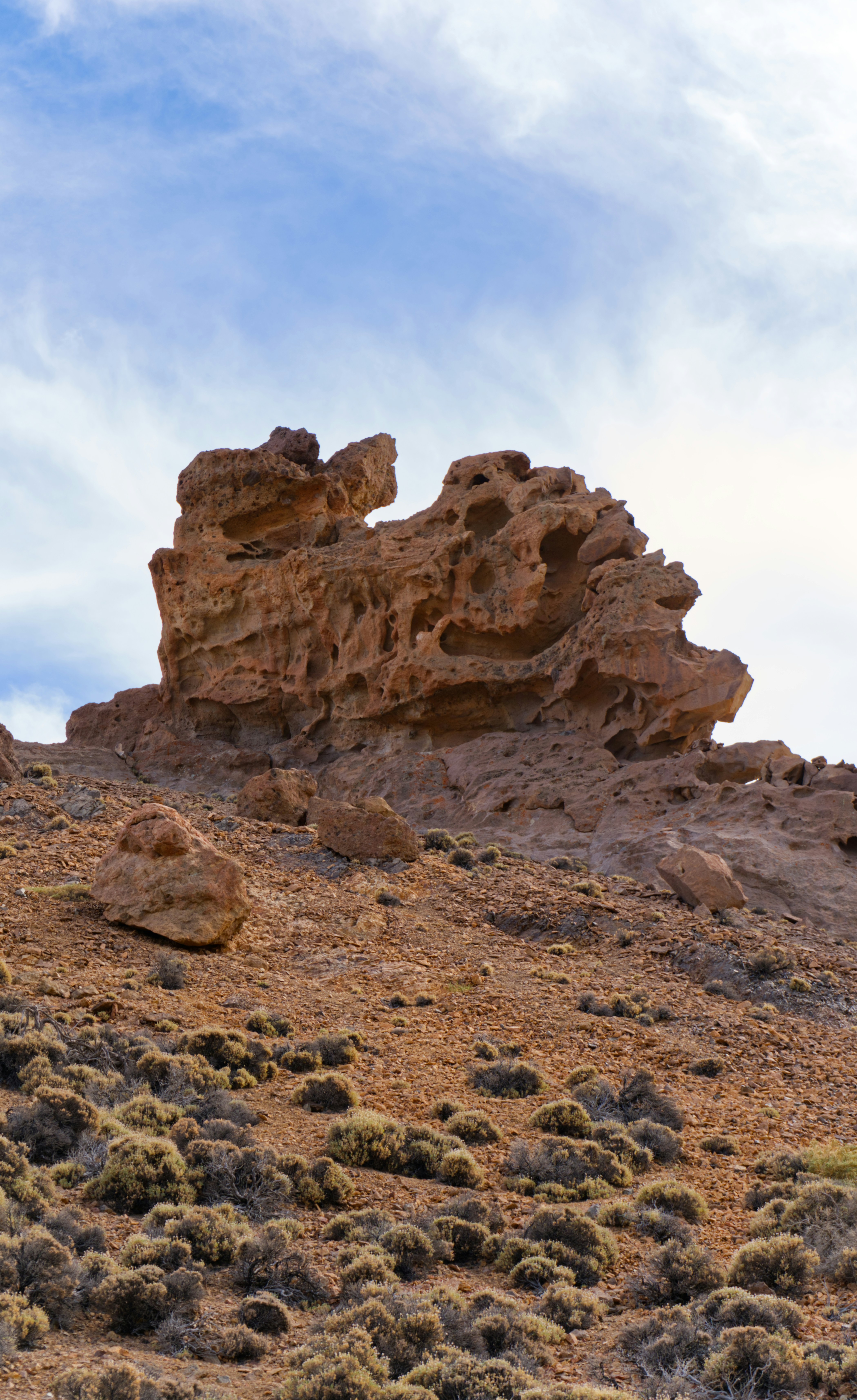 Unusual rock formation on a dry, rocky hillside.