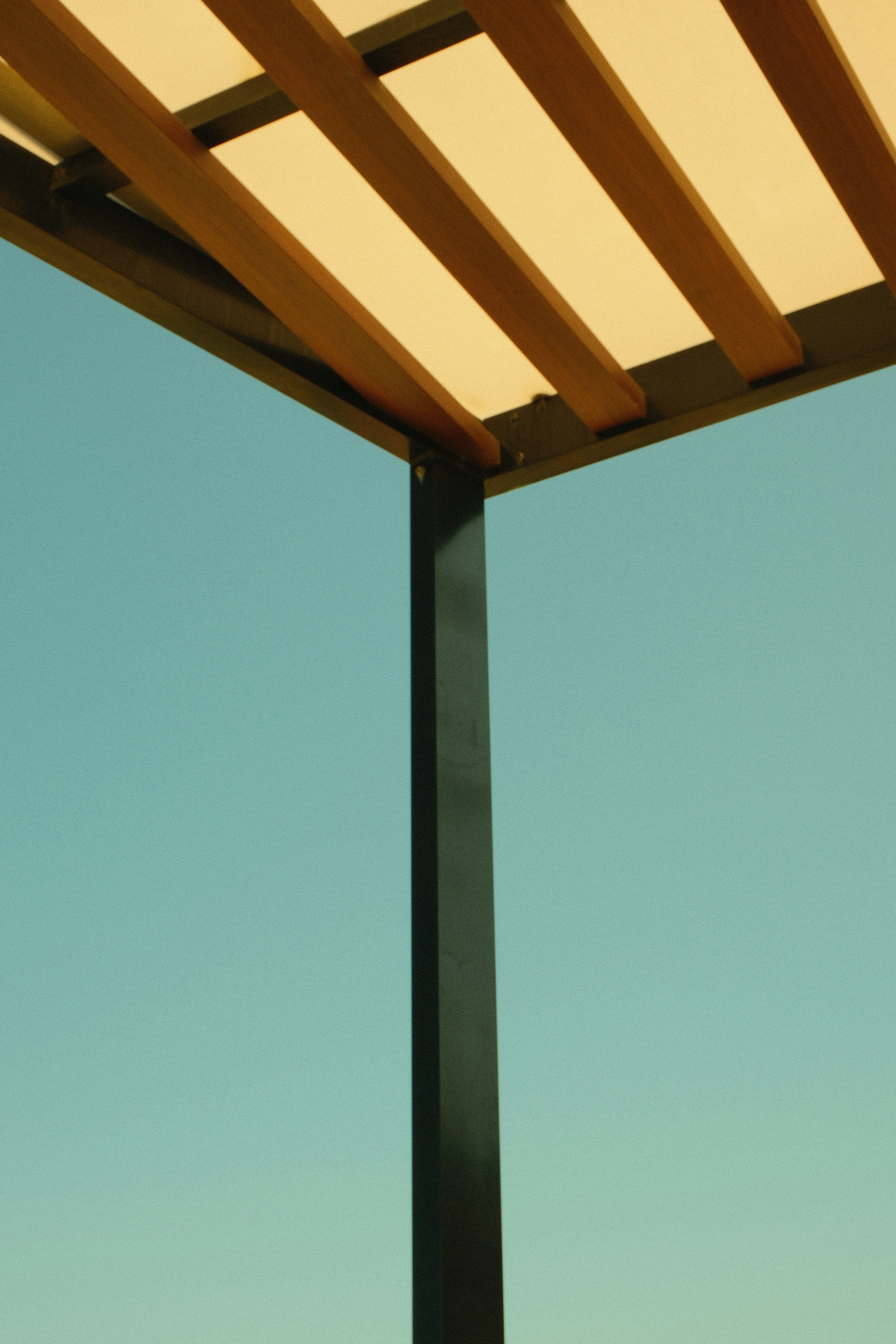 Intersecting Beams Against a Gradient Turquoise Sky: Geometry of a Modern Pergola