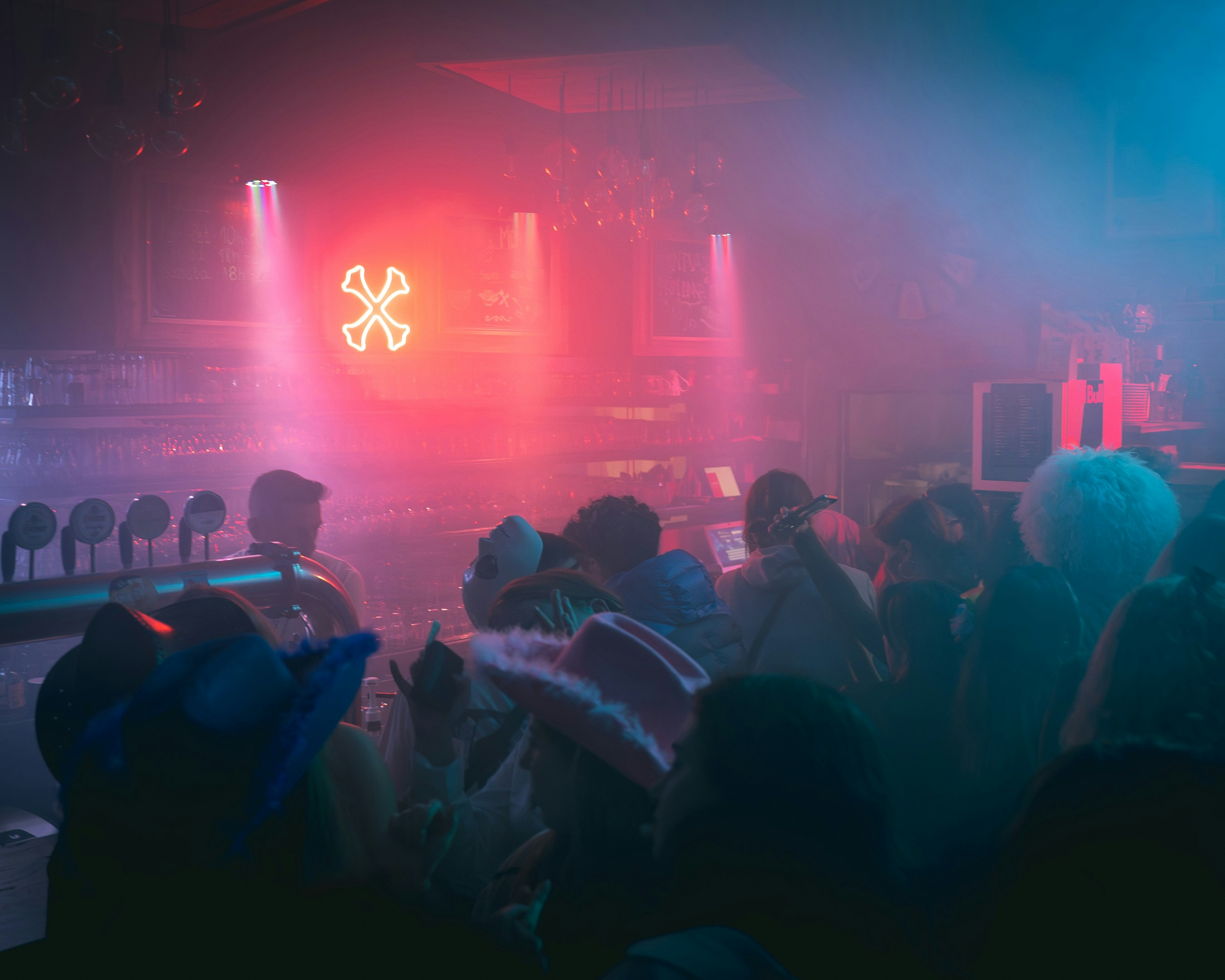 Crowd at a concert with colorful stage lights