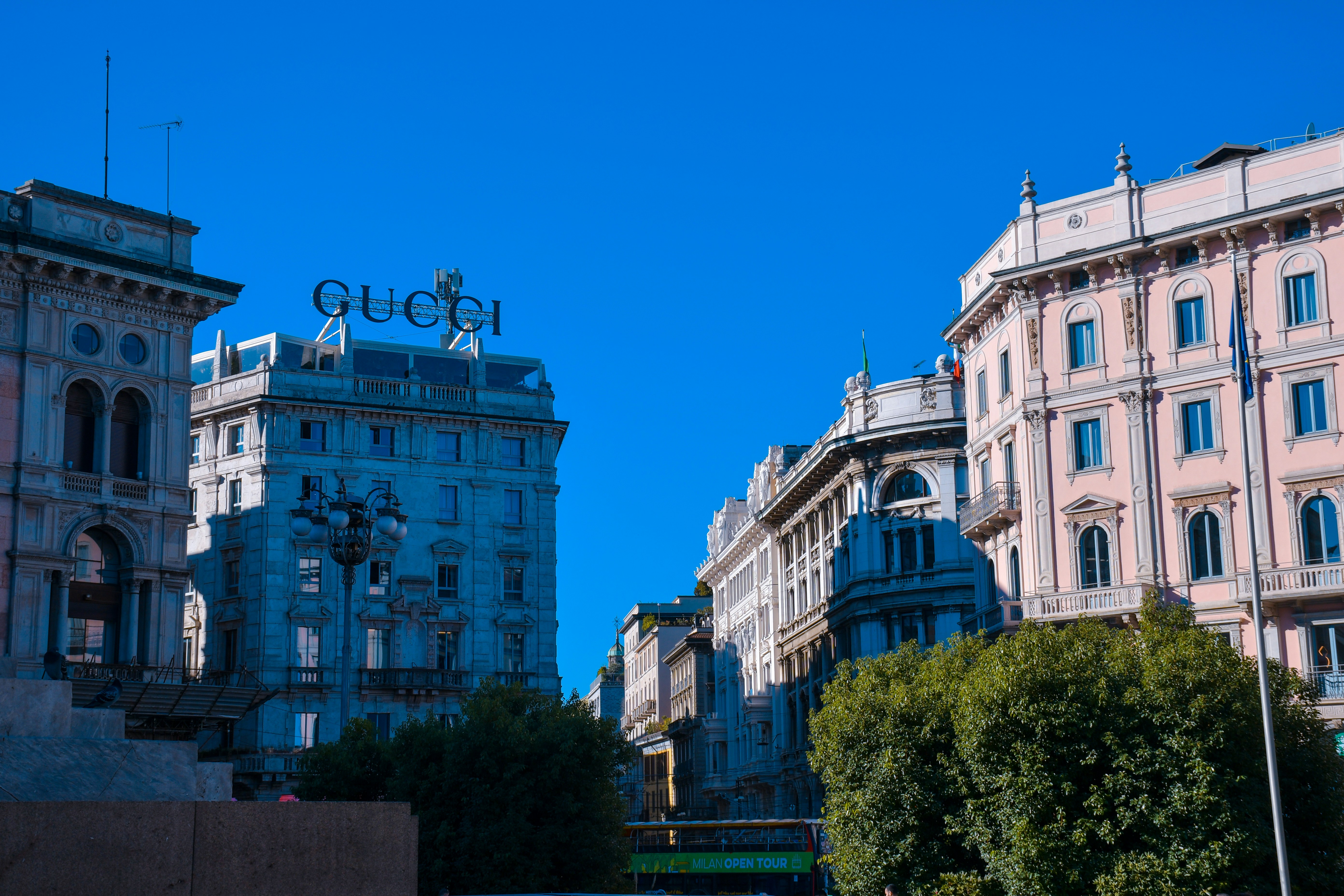 Buildings with gucci sign under clear blue sky
