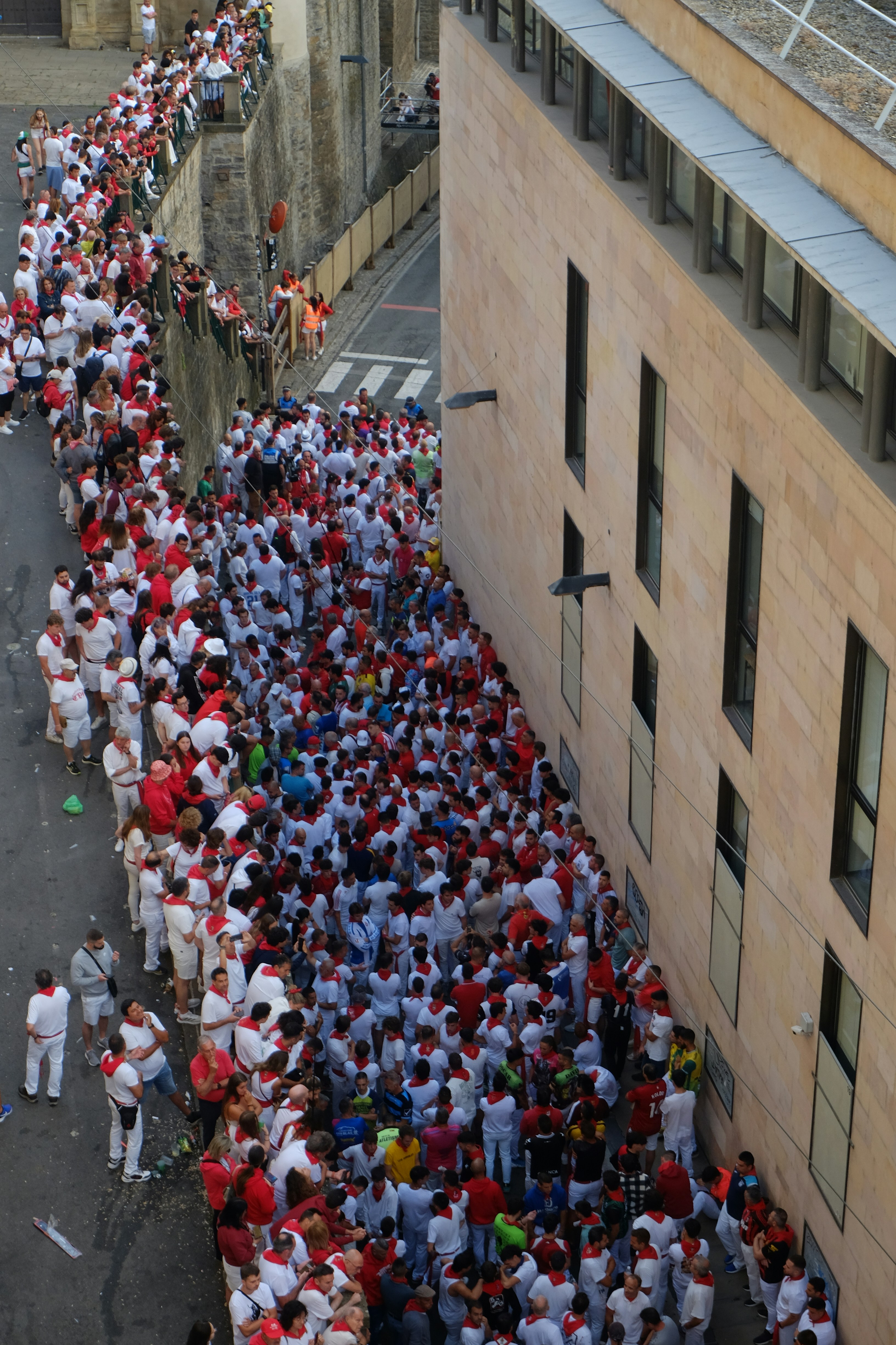 Crowd of people in white shirts and red sashes