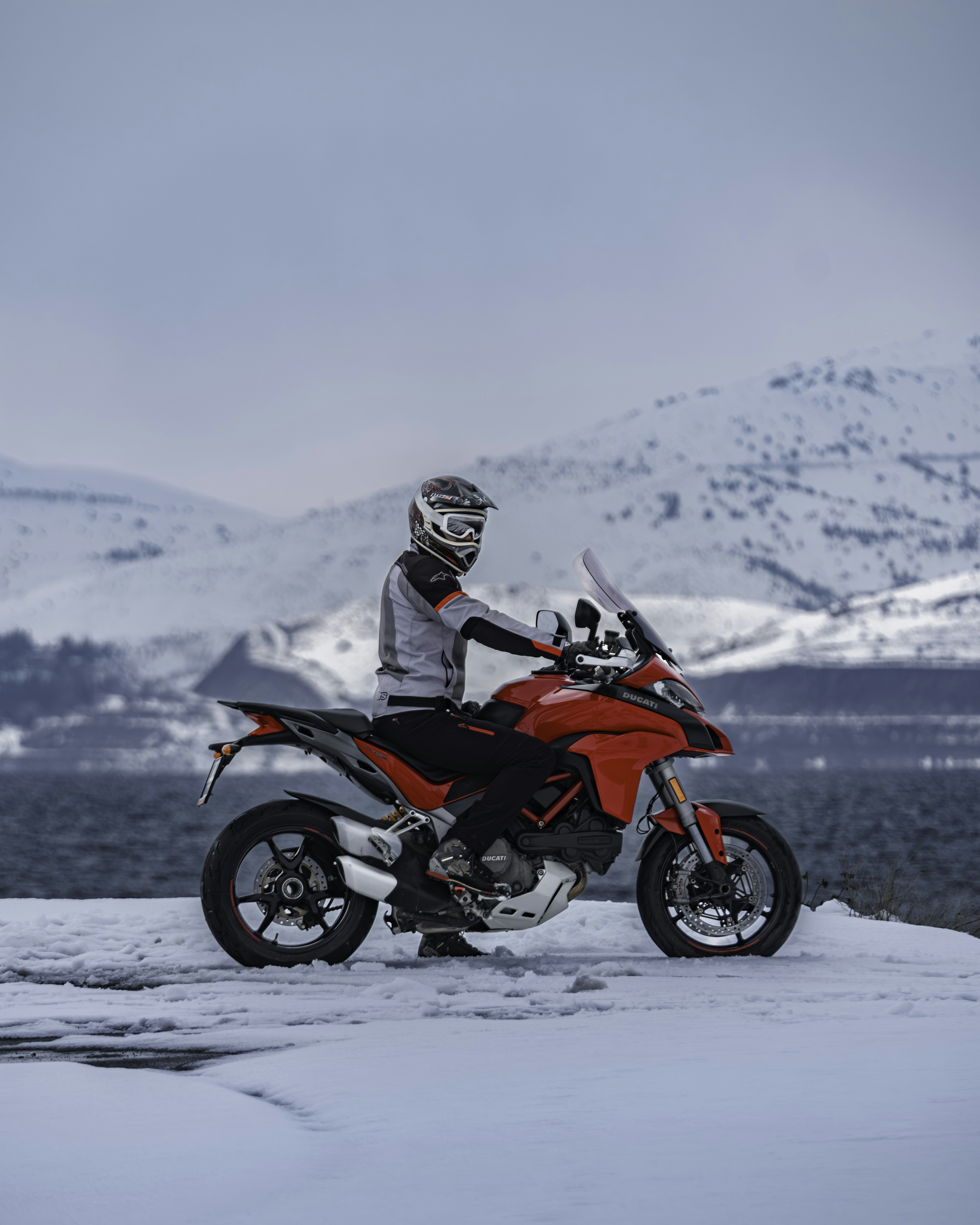 Crimson Moto on a Snow-Kissed Shoreline