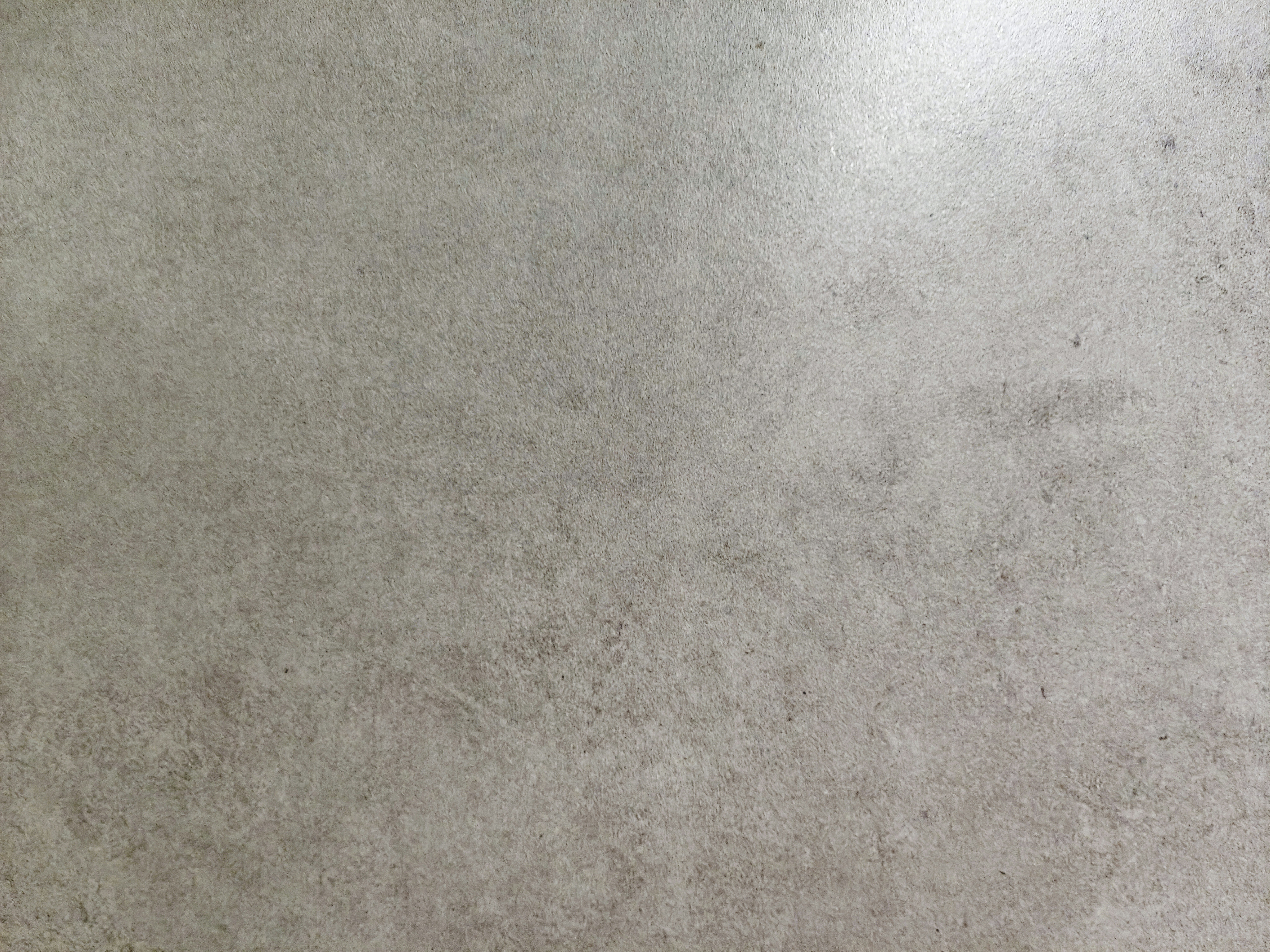 A textured concrete surface with subtle variations.