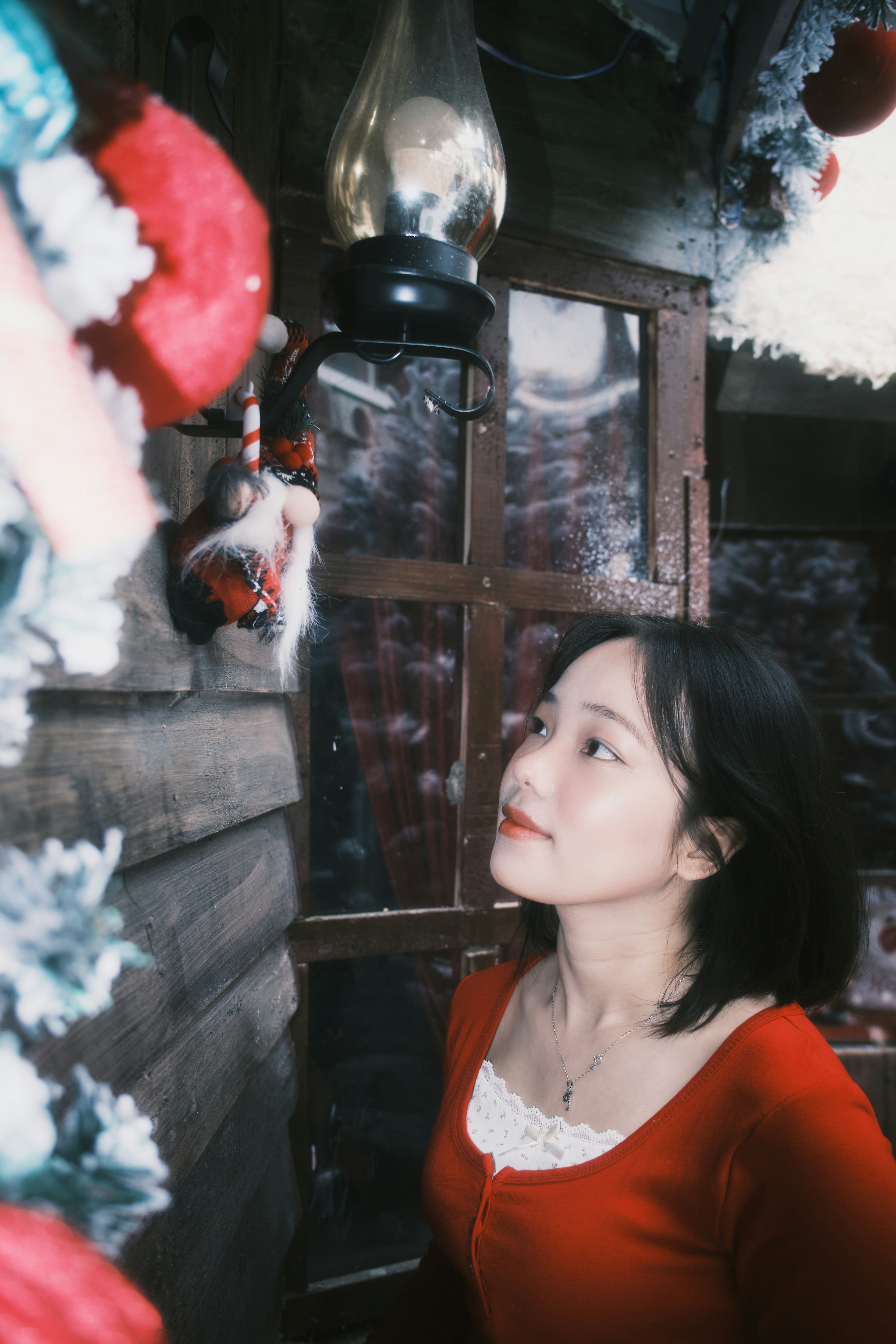 Crimson Quiet Beneath a Lantern in a Winter-Wood Cabin