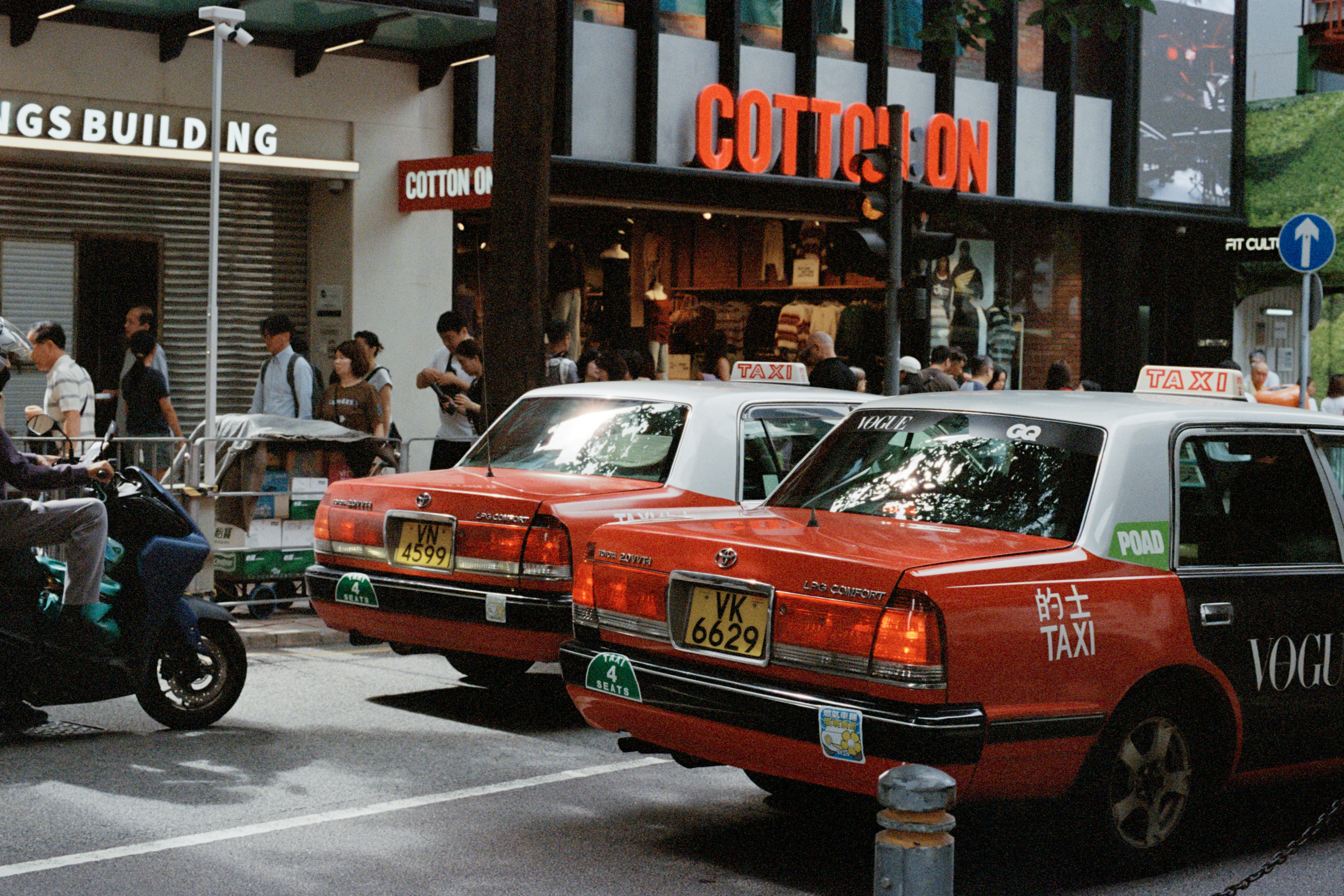 Two red taxis parked on a city street. photo – Free Travel Image on ...