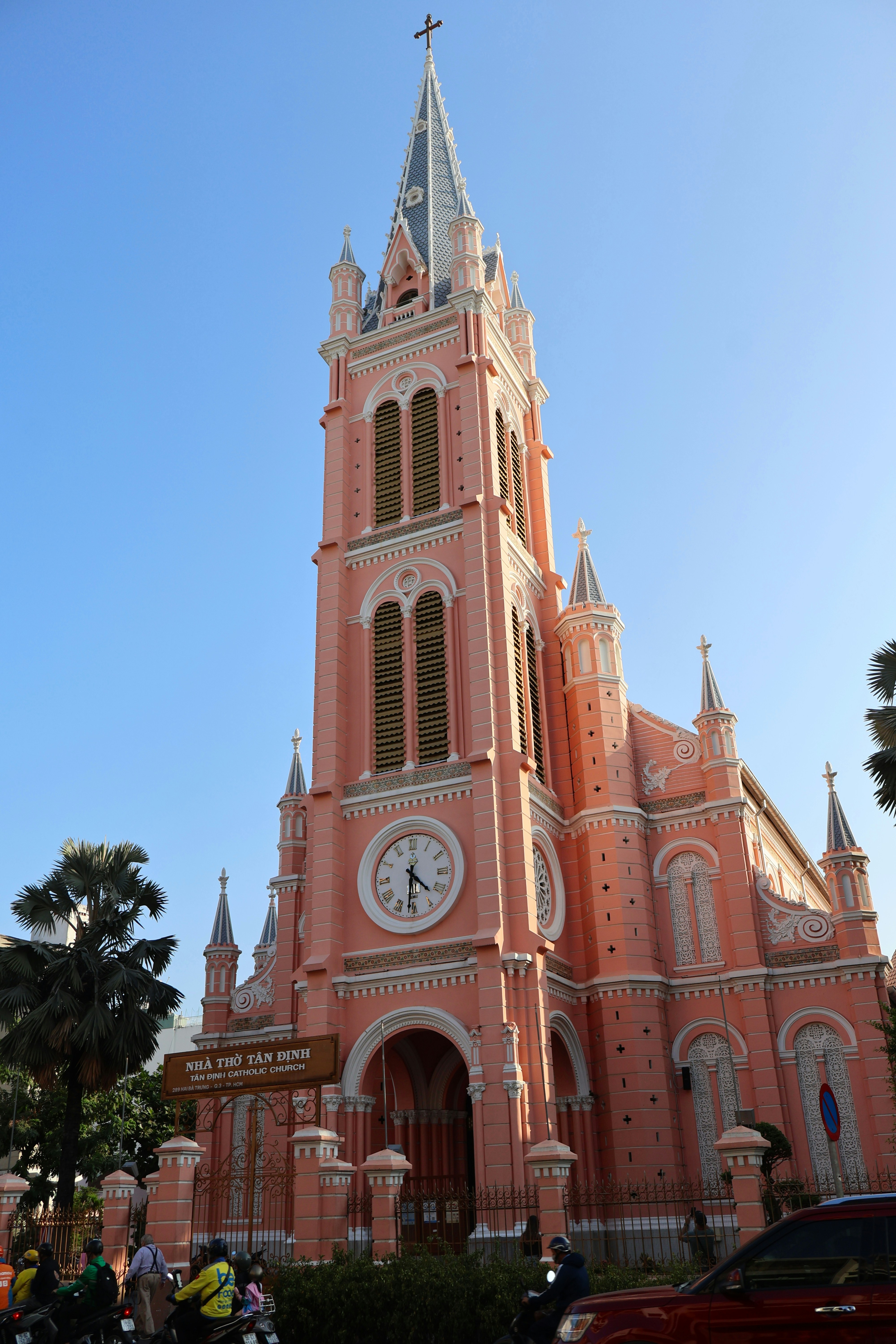 A tall pink church with a clock tower.