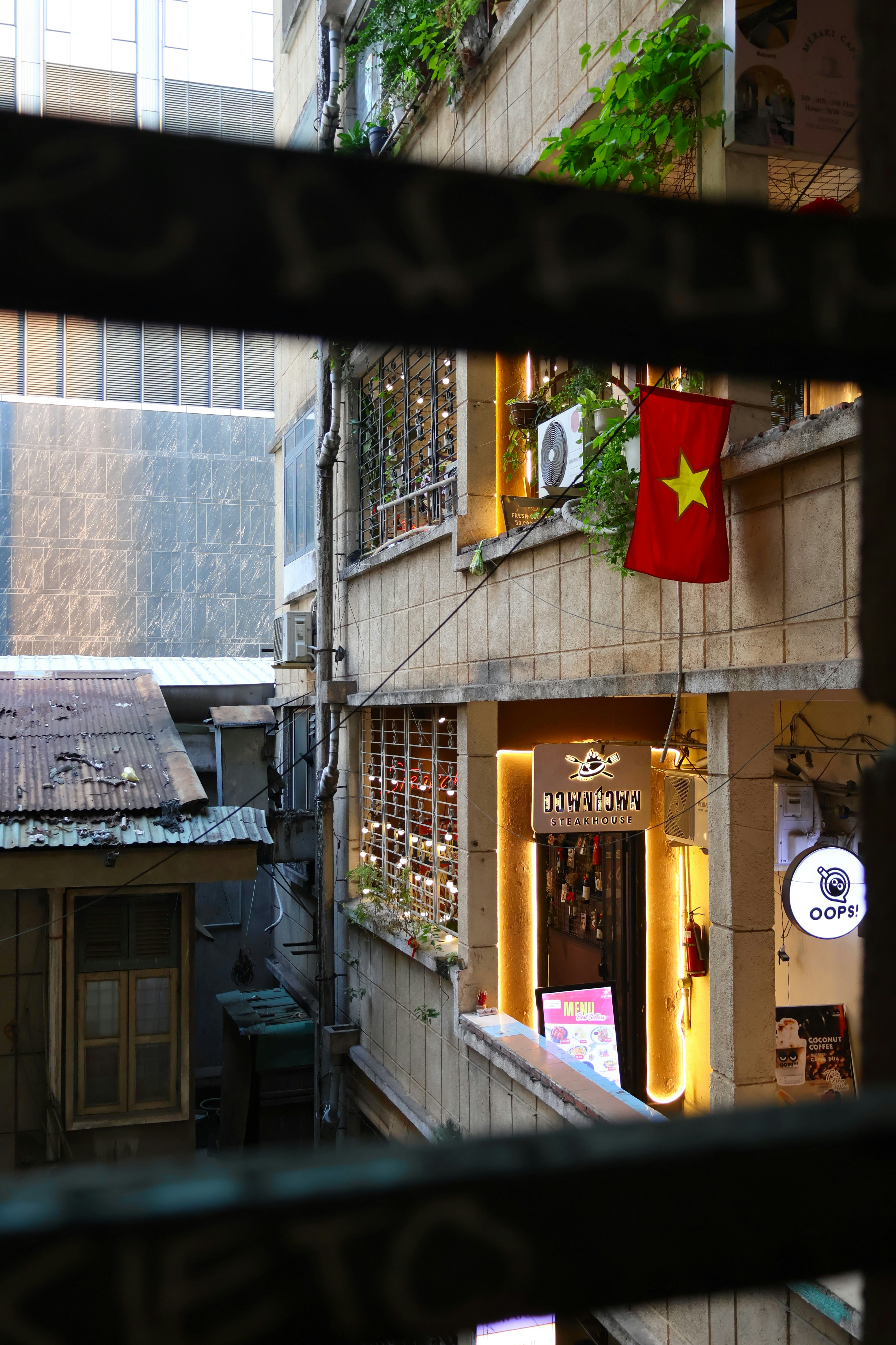 Vietnamese flag hangs above a restaurant entrance.