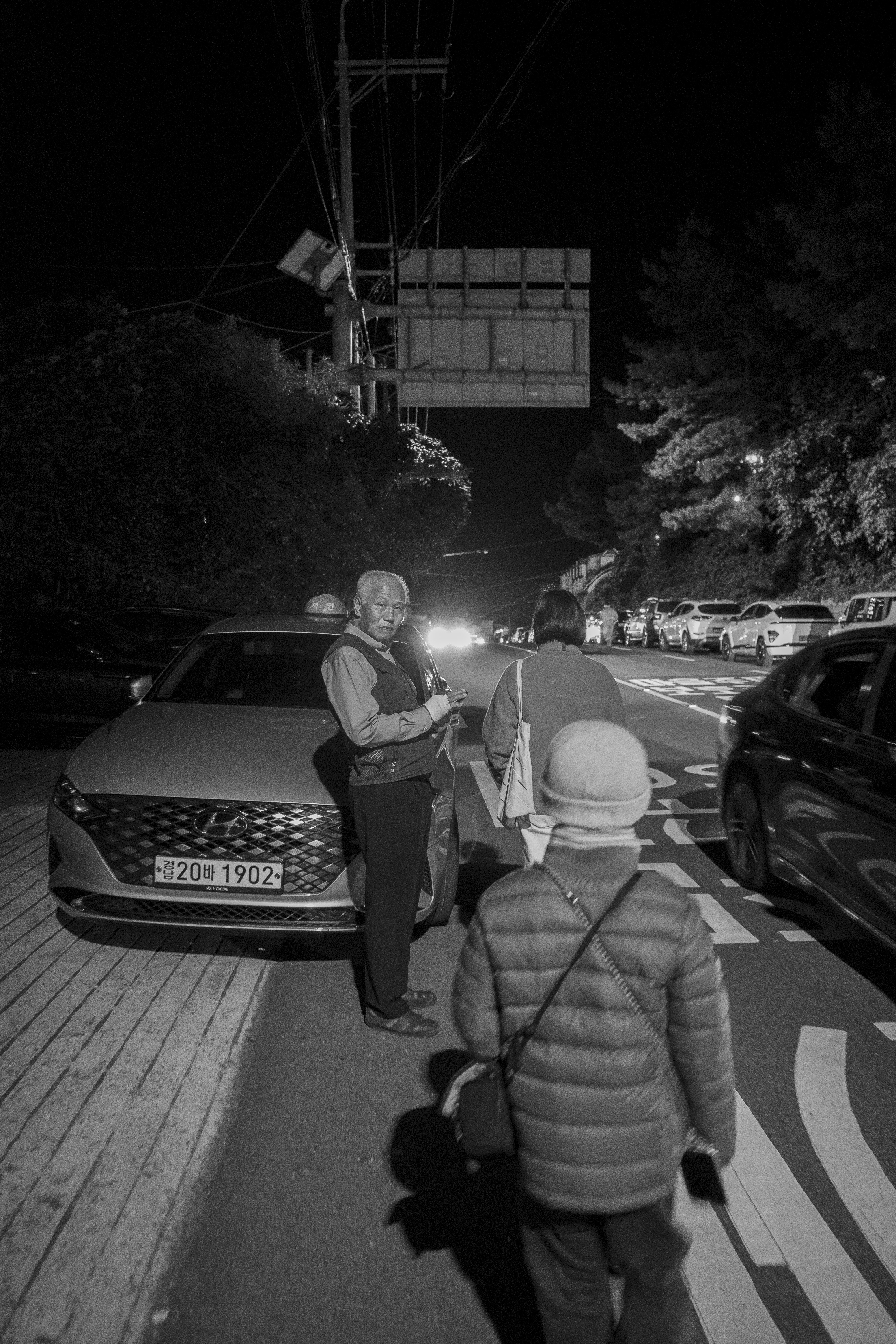 Curbside Conversation Under a Streetlight