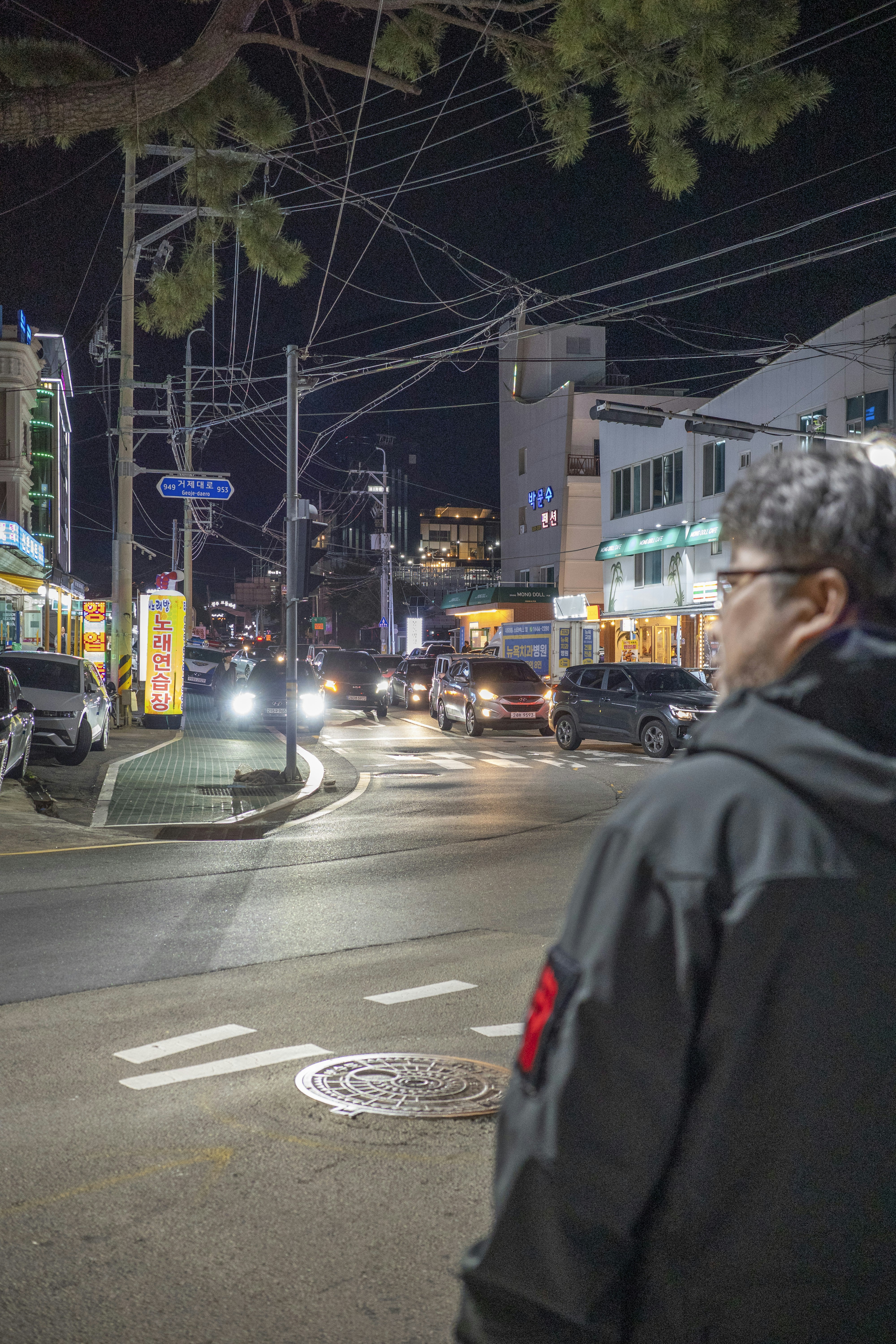 Neon Crossroads: Night Street with a Watchful Stranger